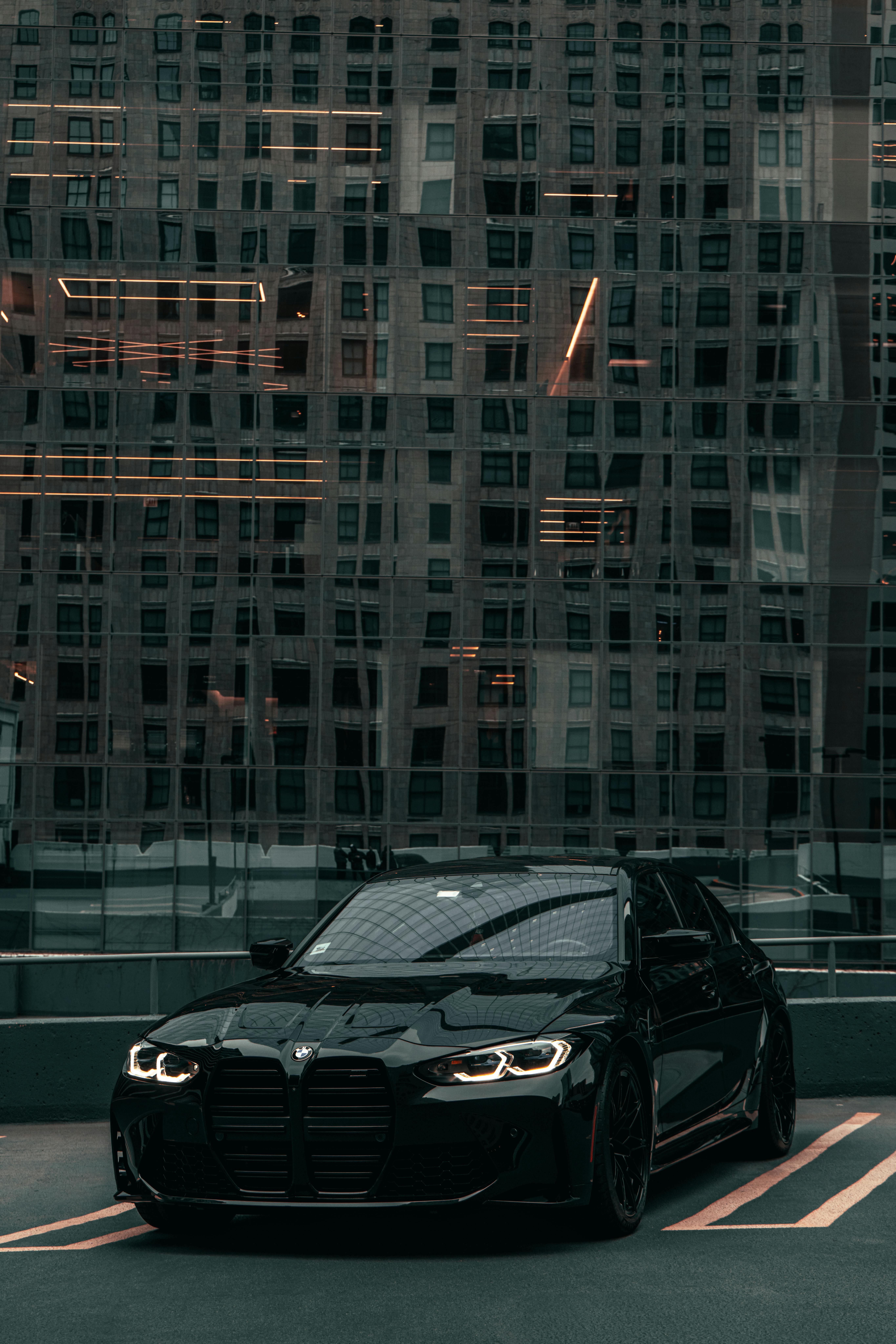 Sleek Black Car in Urban Rooftop Setting · Free Stock Photo