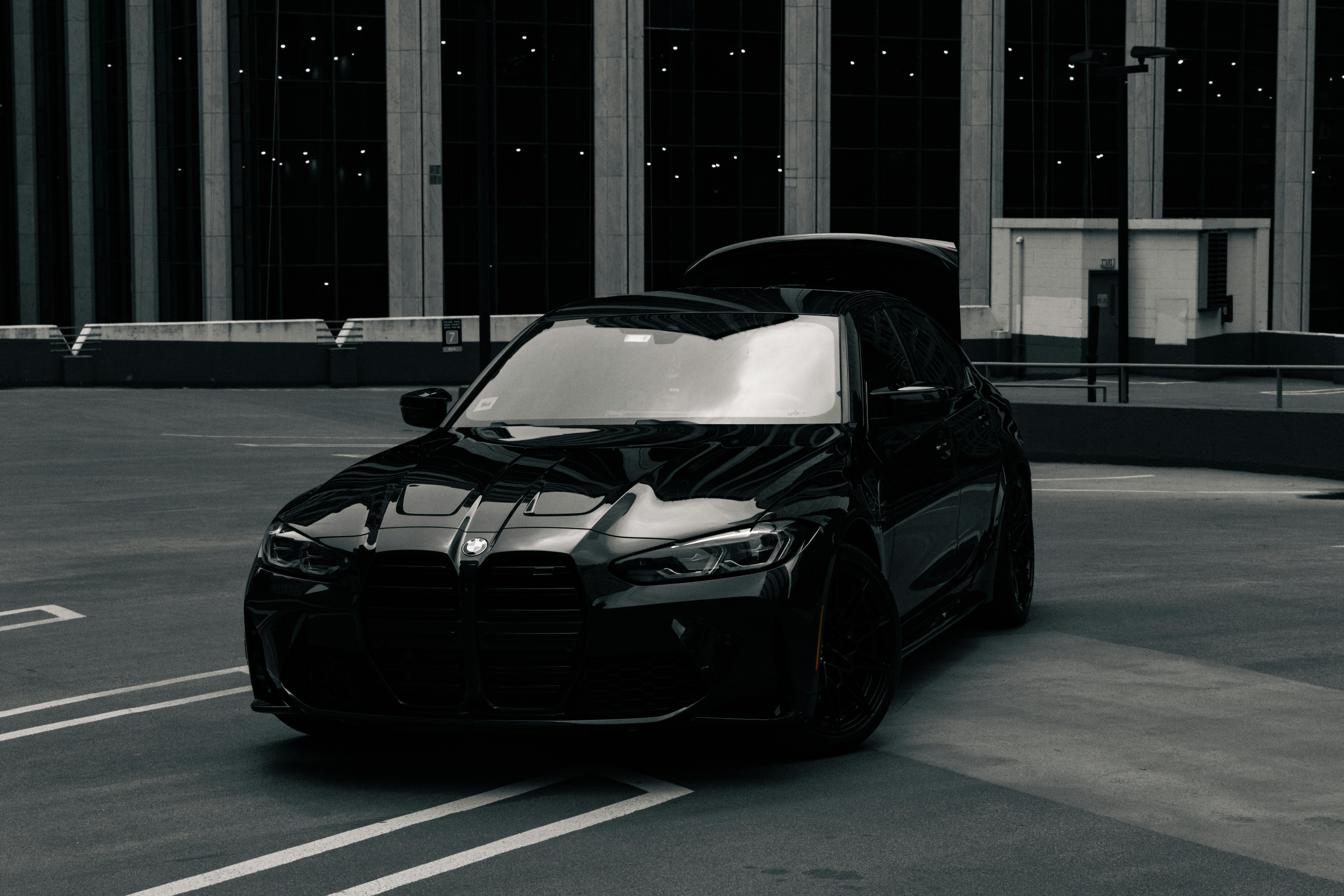 Sleek Black Car in Urban Rooftop Setting · Free Stock Photo