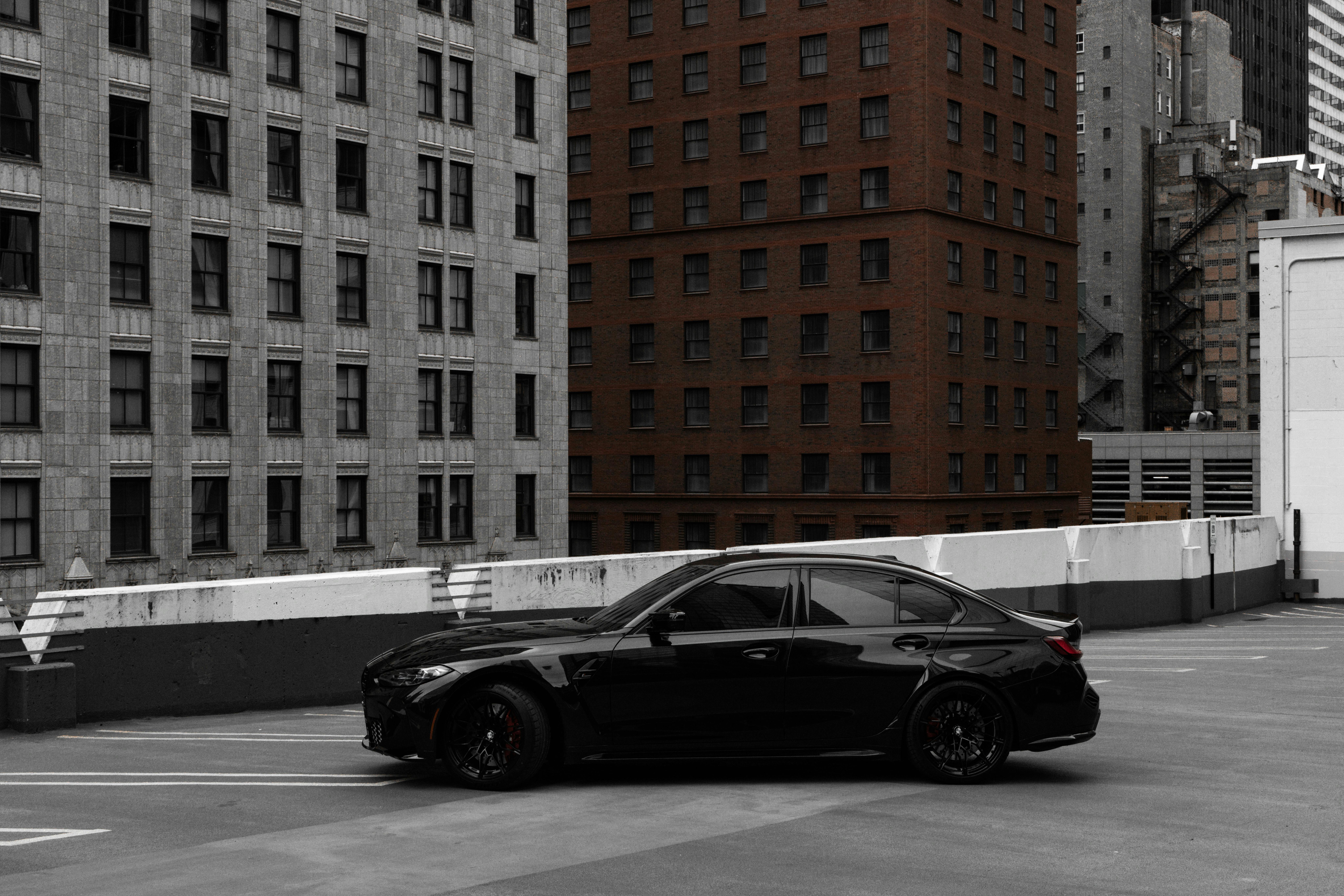 Sleek Black Car in Urban Rooftop Setting · Free Stock Photo