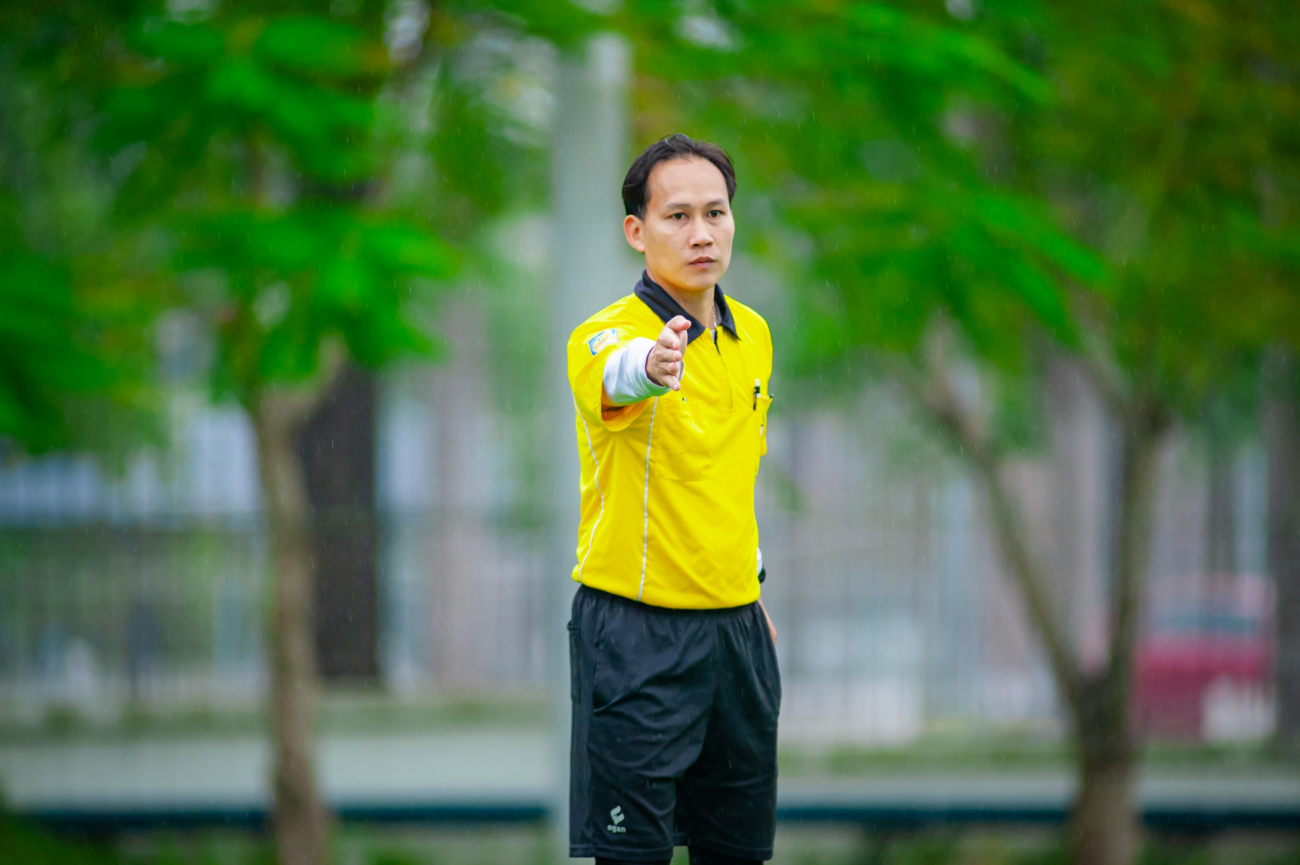 Referee in Action During Soccer Match · Free Stock Photo