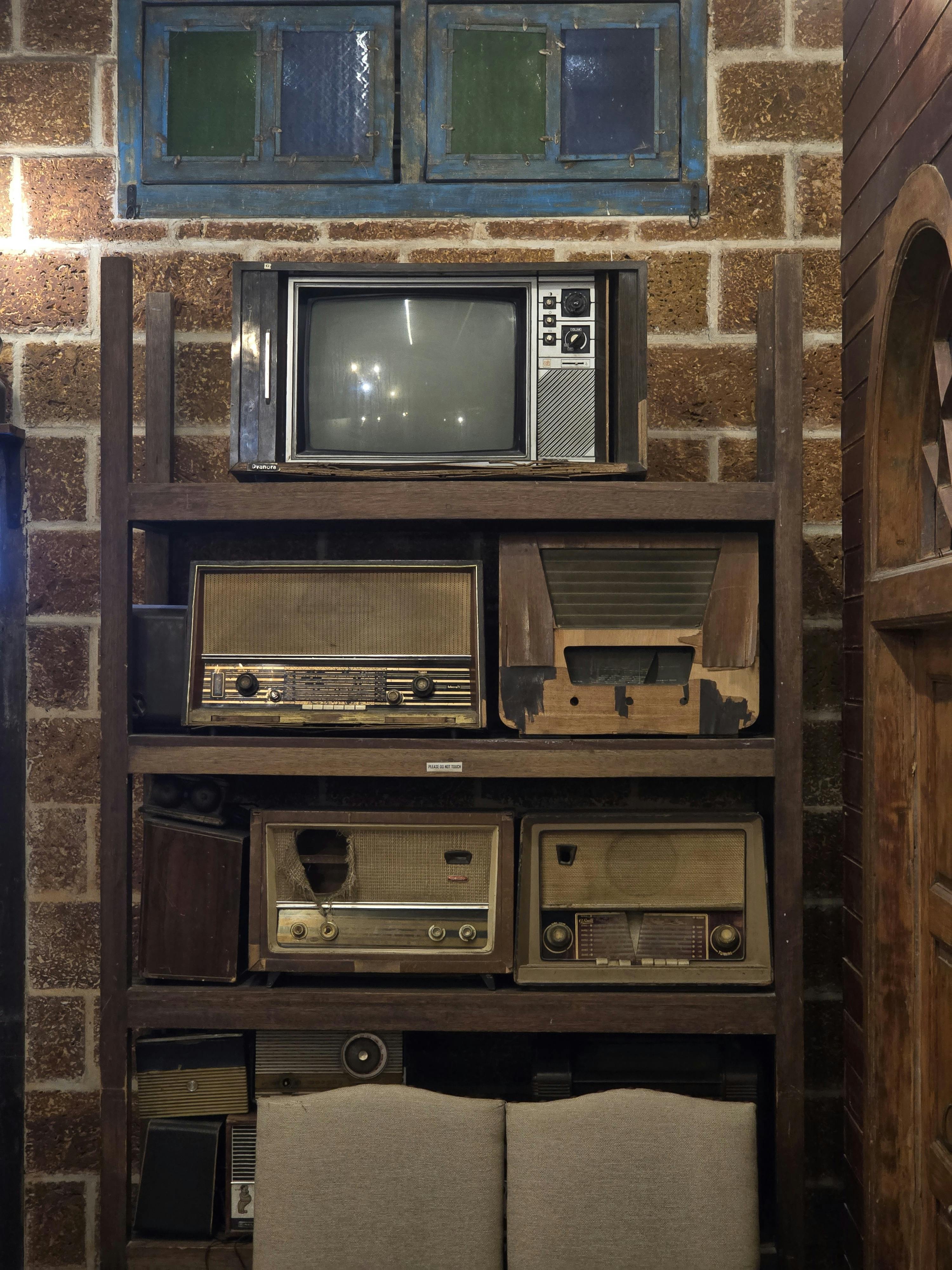 Vintage Electronics Display on Rustic Shelves · Free Stock Photo