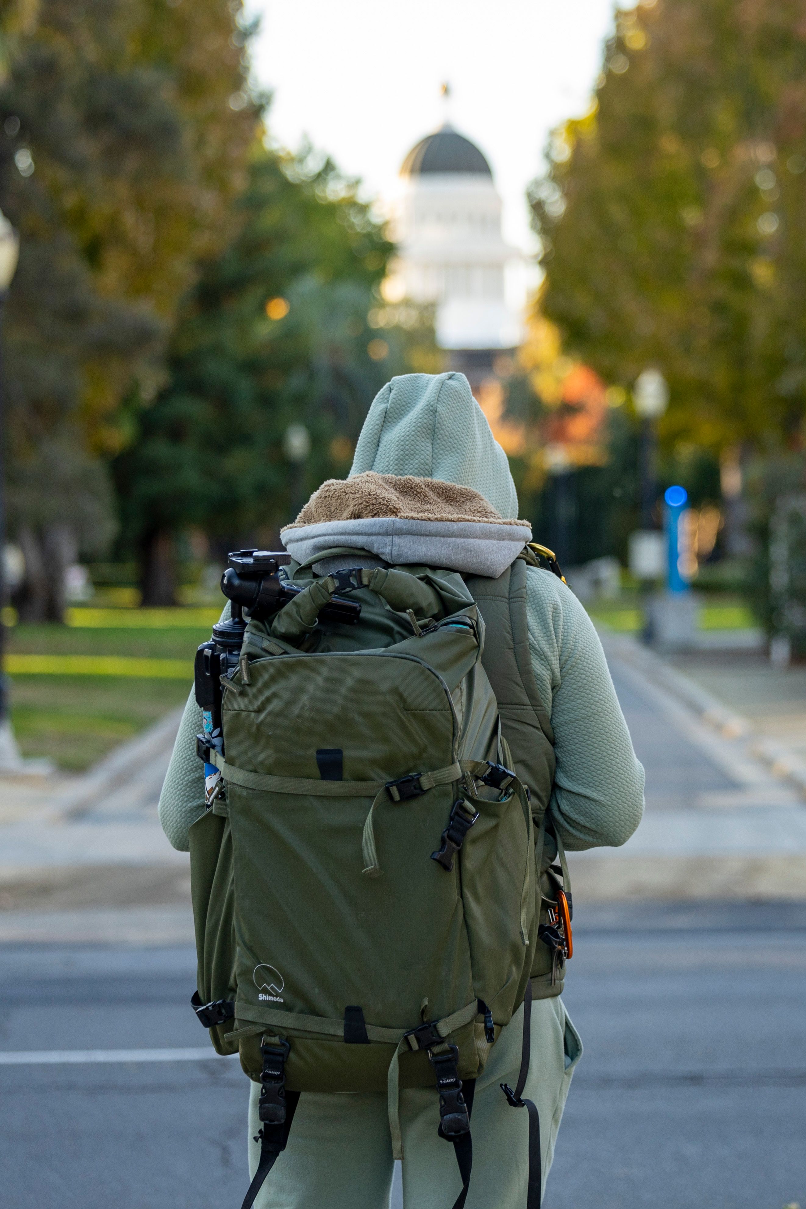 Hiker with Backpack in Urban Park Setting · Free Stock Photo