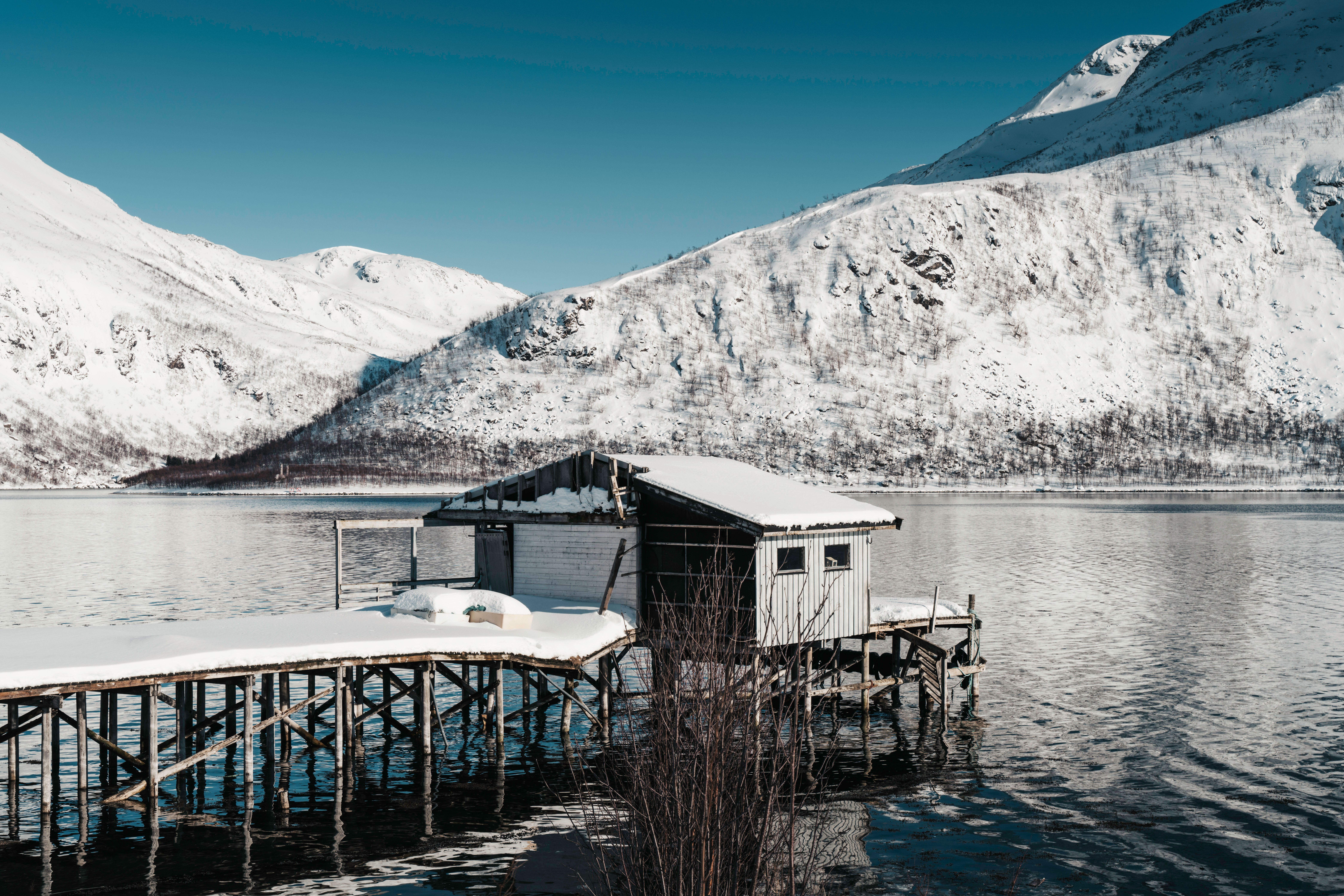 Snowy Cabin on a Norwegian Fjord, Peaceful Winter Scene · Free Stock Photo