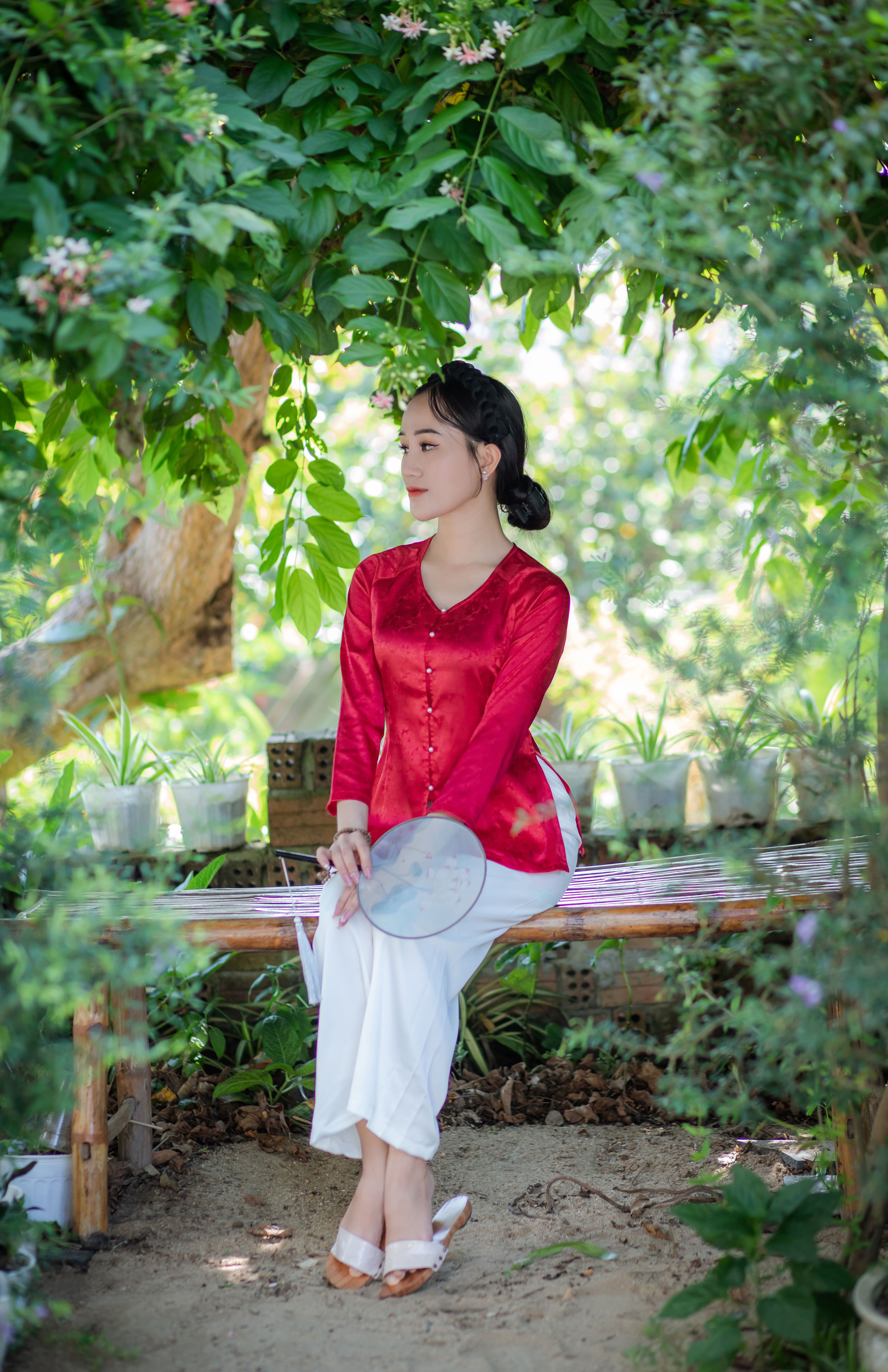 Vietnamese Woman in Traditional Silk Attire Outdoors · Free Stock Photo