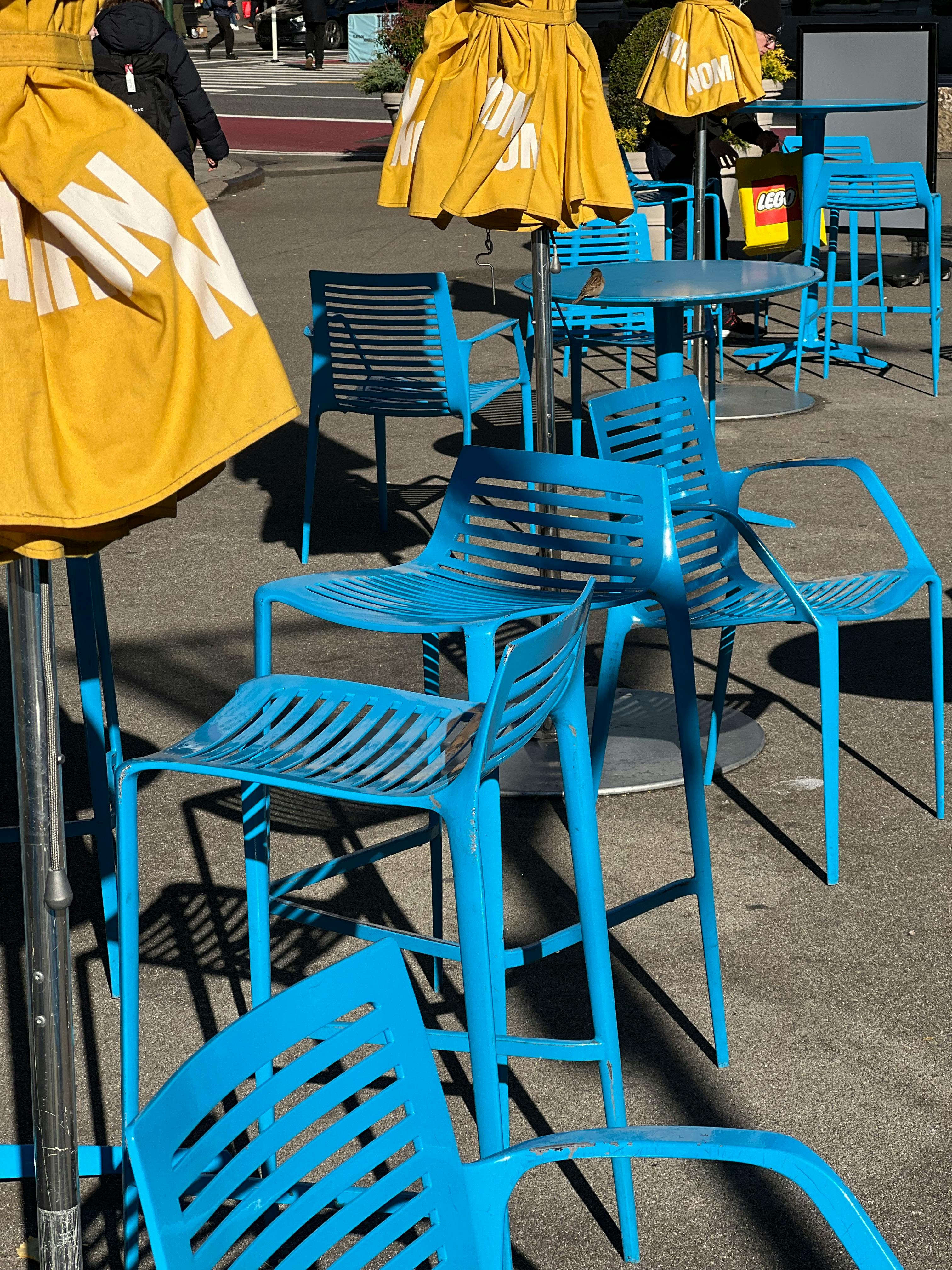 Vibrant Outdoor Cafe Setting with Blue Chairs · Free Stock Photo