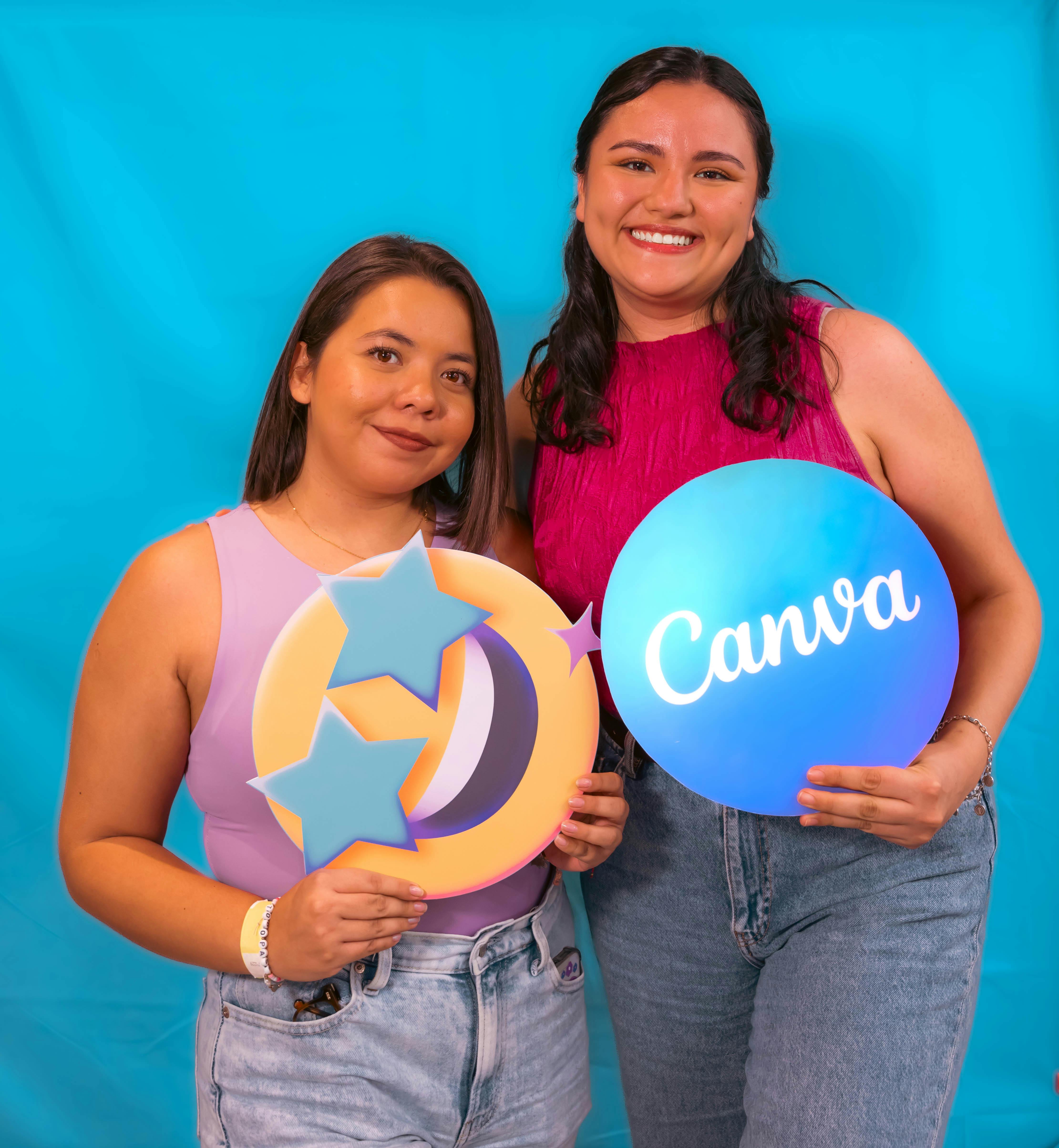 Two Women Holding Canva and Star Symbols · Free Stock Photo