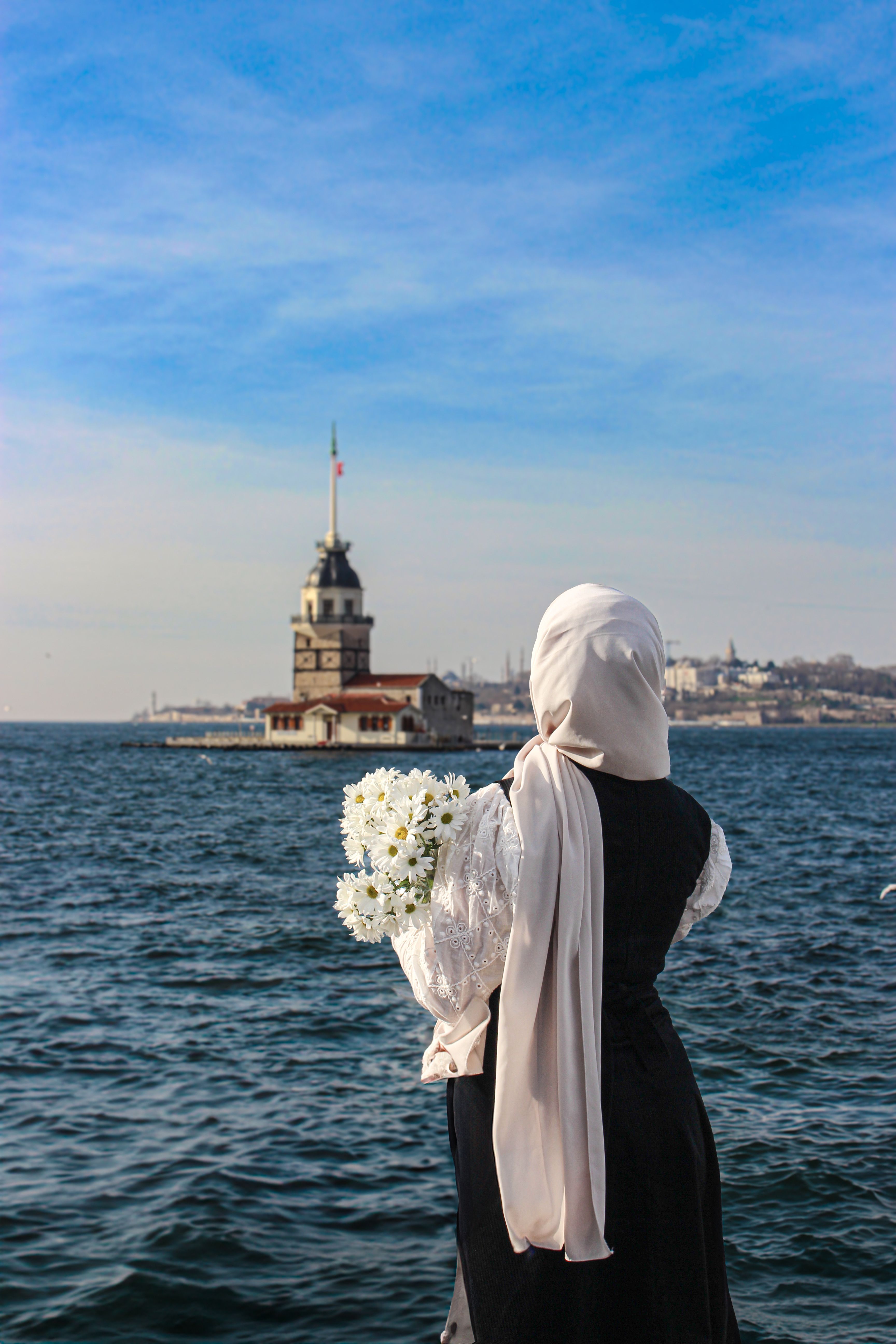 Woman in Hijab Overlooking Maiden's Tower in Istanbul · Free Stock Photo