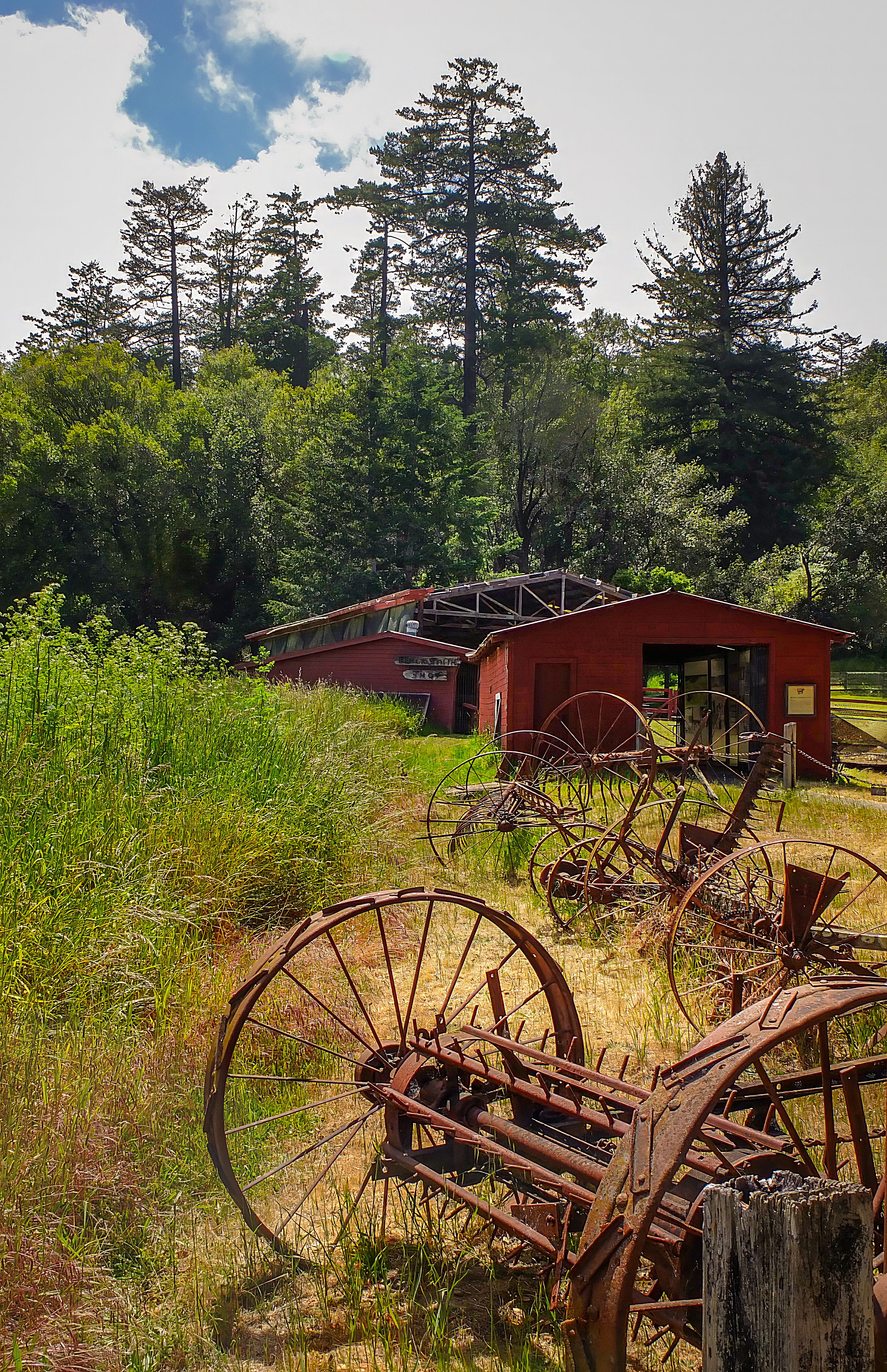 Vintage Farm Equipment at Rustic Red Barn · Free Stock Photo
