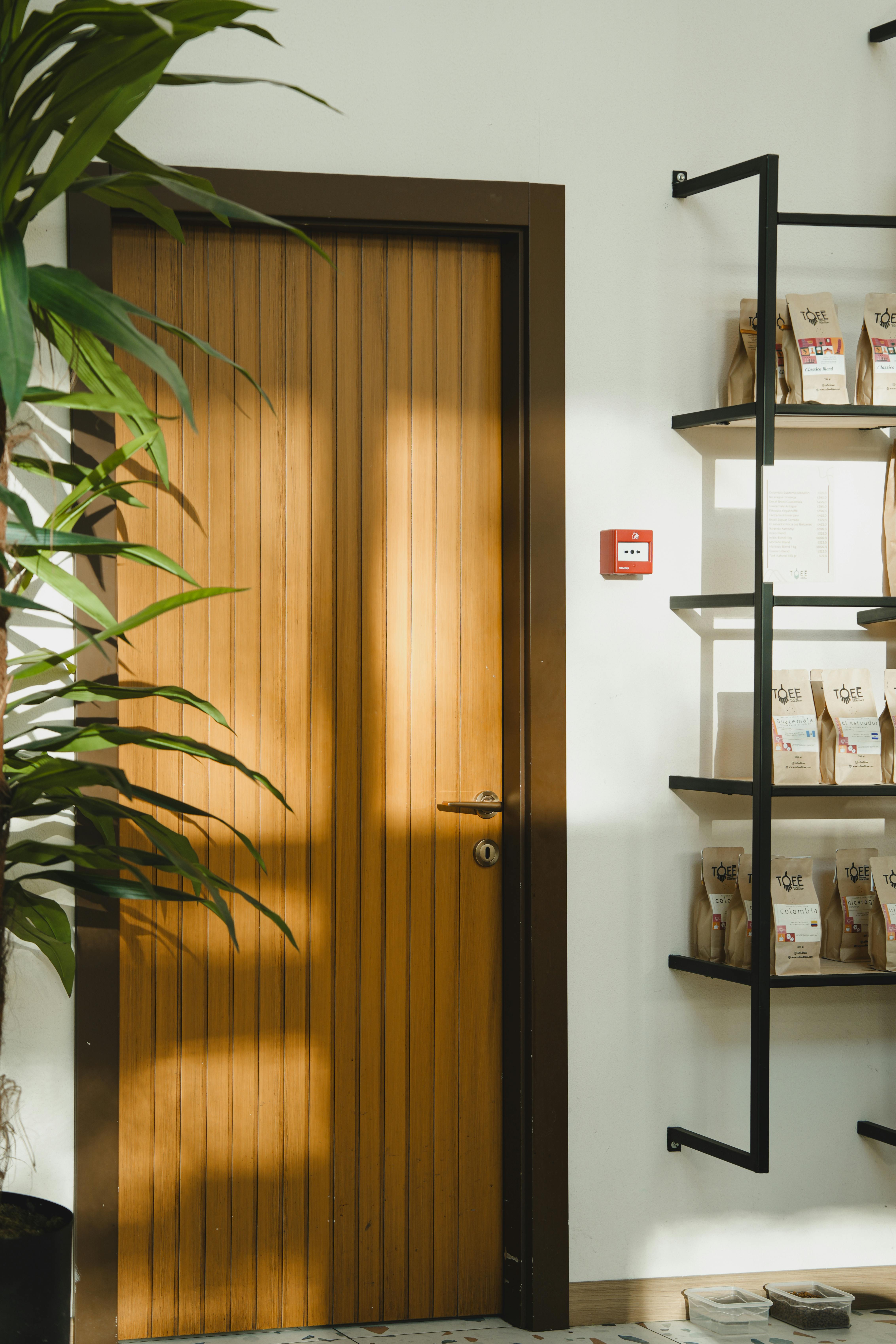 Cozy Interior with Wooden Door and Shelf · Free Stock Photo