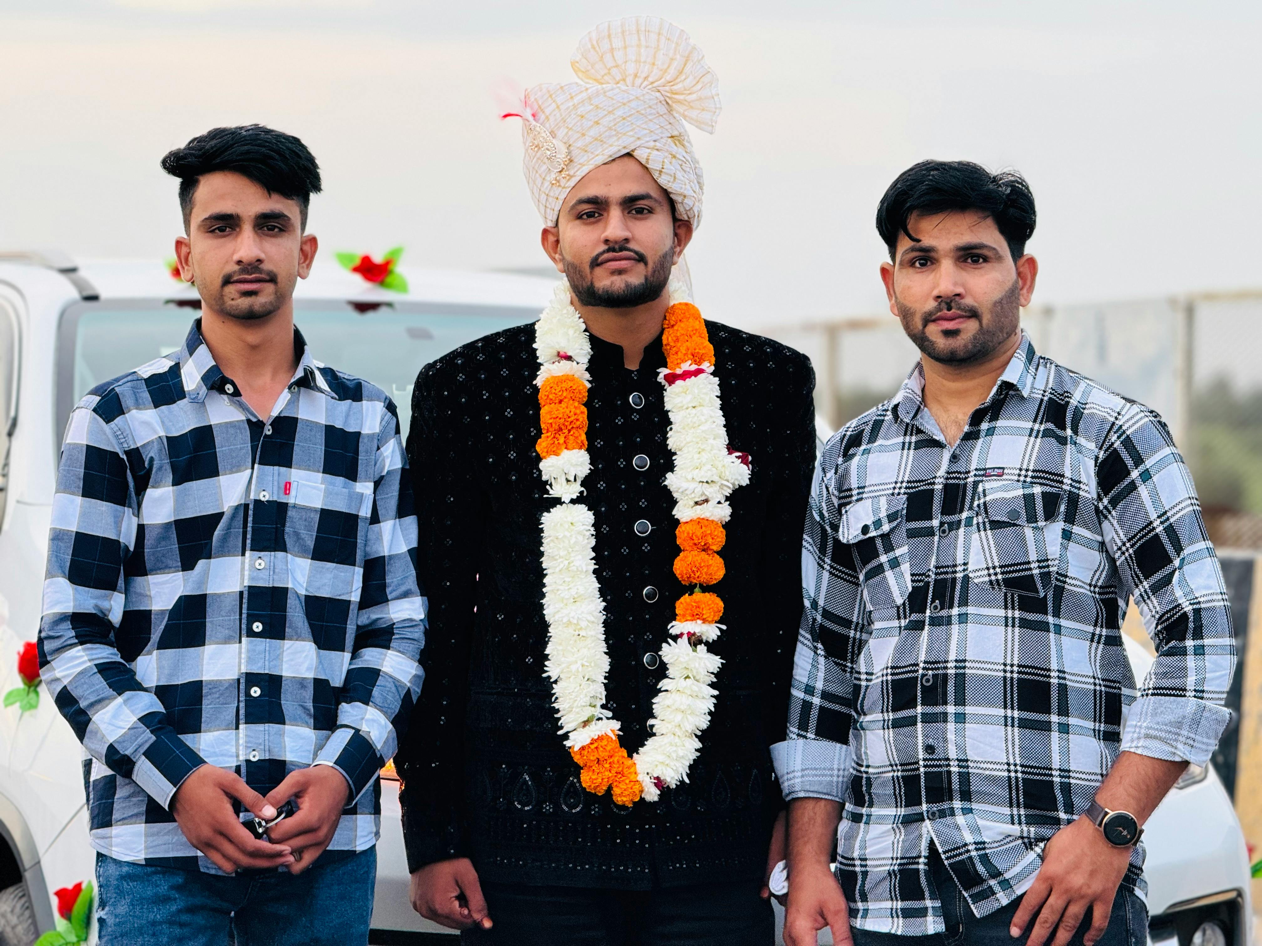 Traditional Wedding Celebration with Three Men Outdoors · Free Stock Photo
