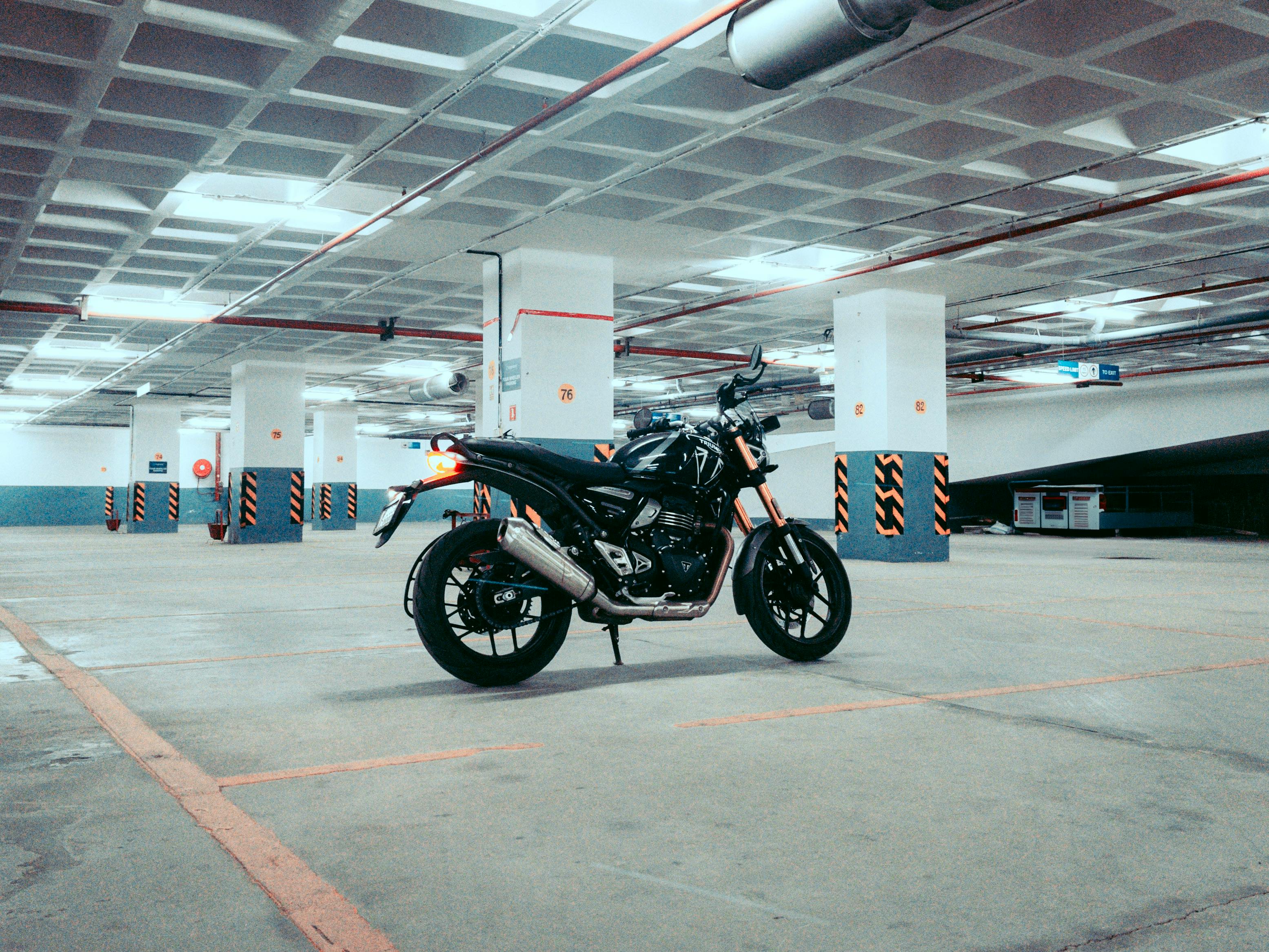 Classic Motorcycle in Underground Parking Area · Free Stock Photo