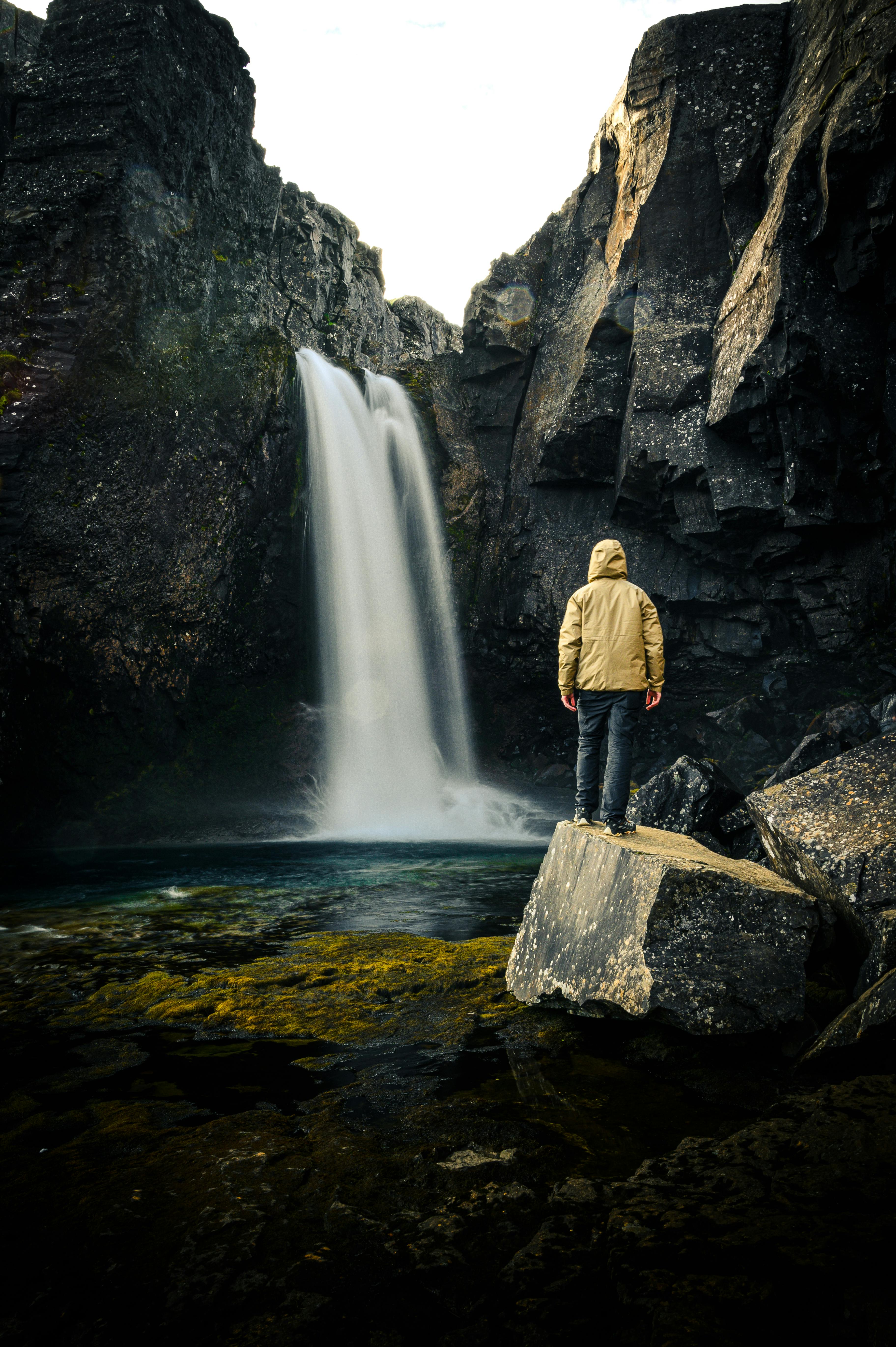 Person Standing Near Waterfalls · Free Stock Photo