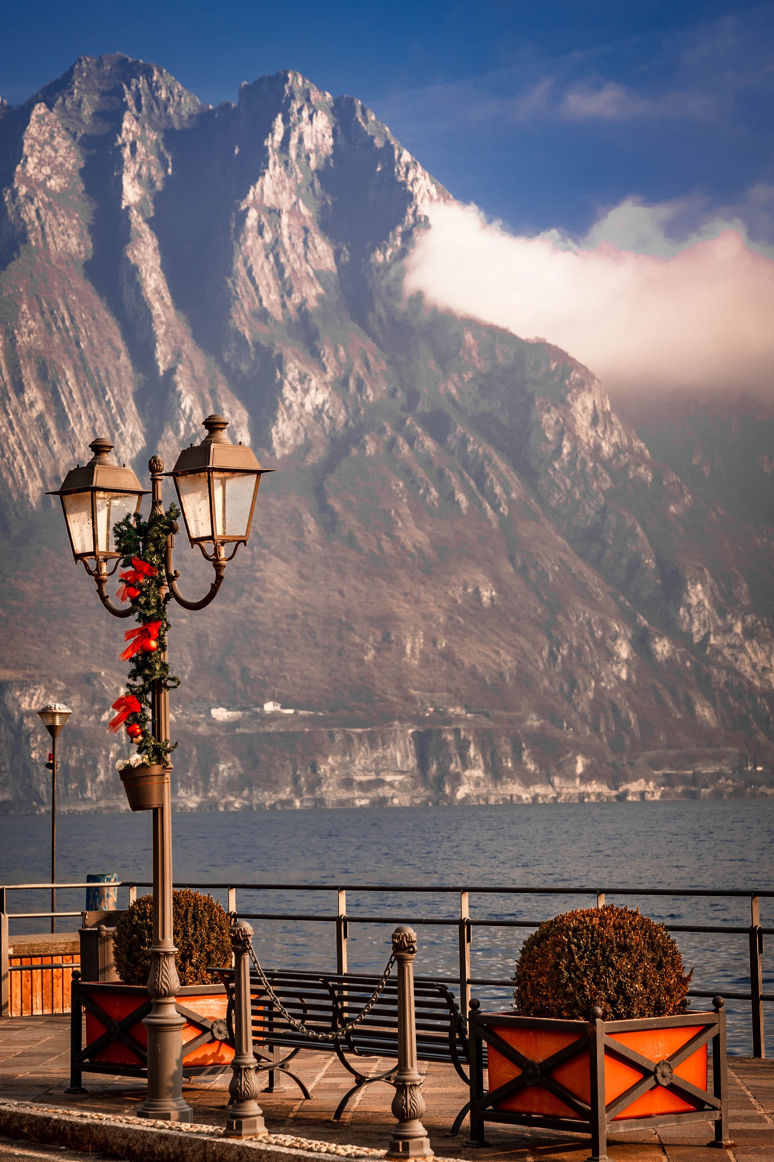 Picturesque Lakeside View with Lamp Post and Mountain · Free Stock Photo