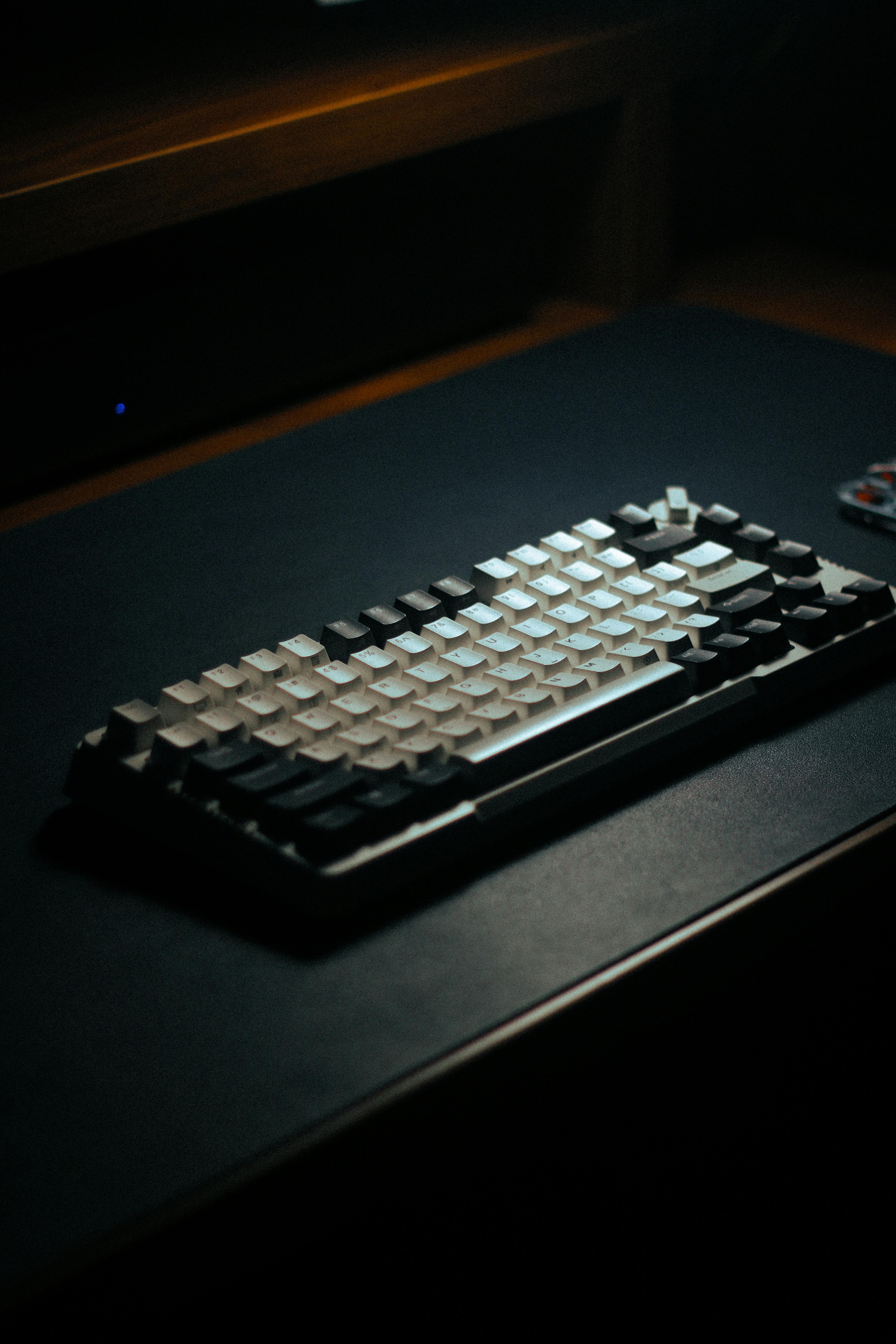 Sleek Mechanical Keyboard on Dark Desk · Free Stock Photo