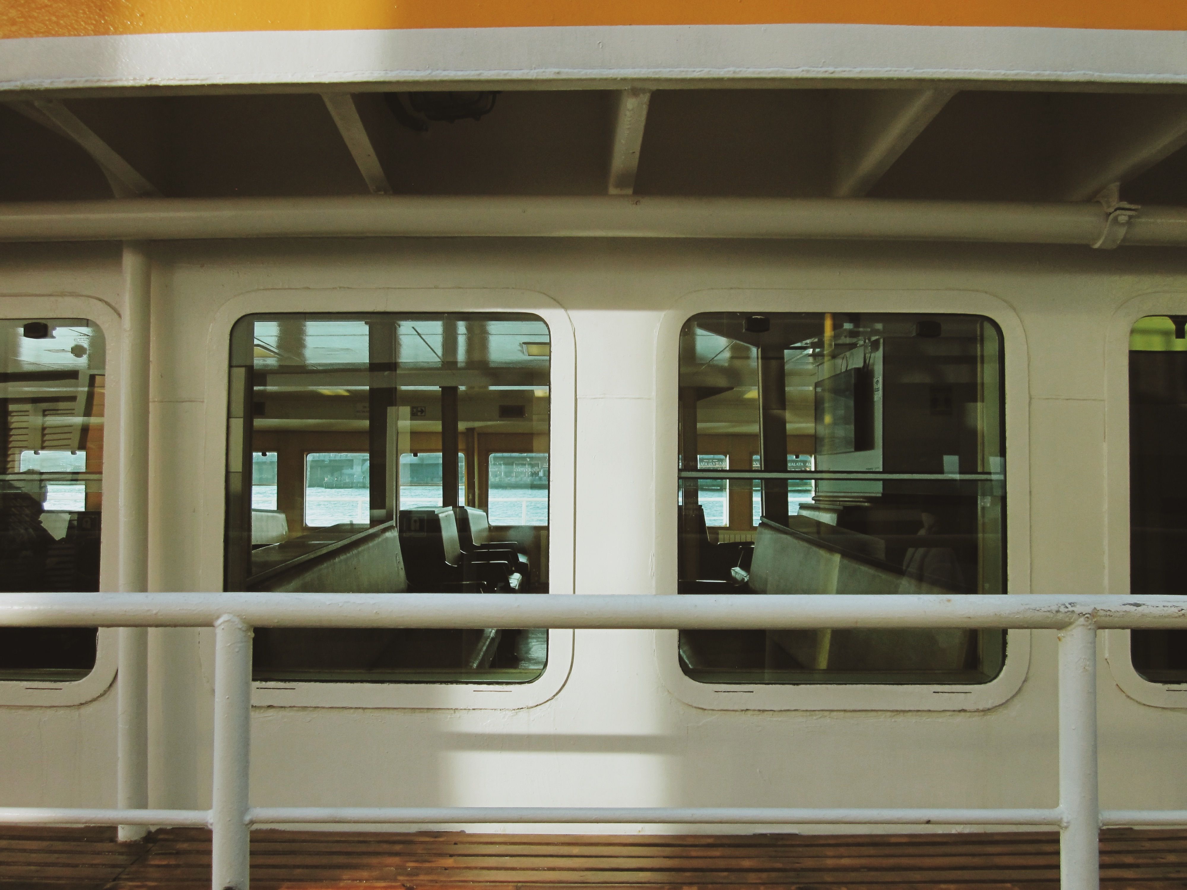 Inside View of Ferry with Reflections and Seating · Free Stock Photo