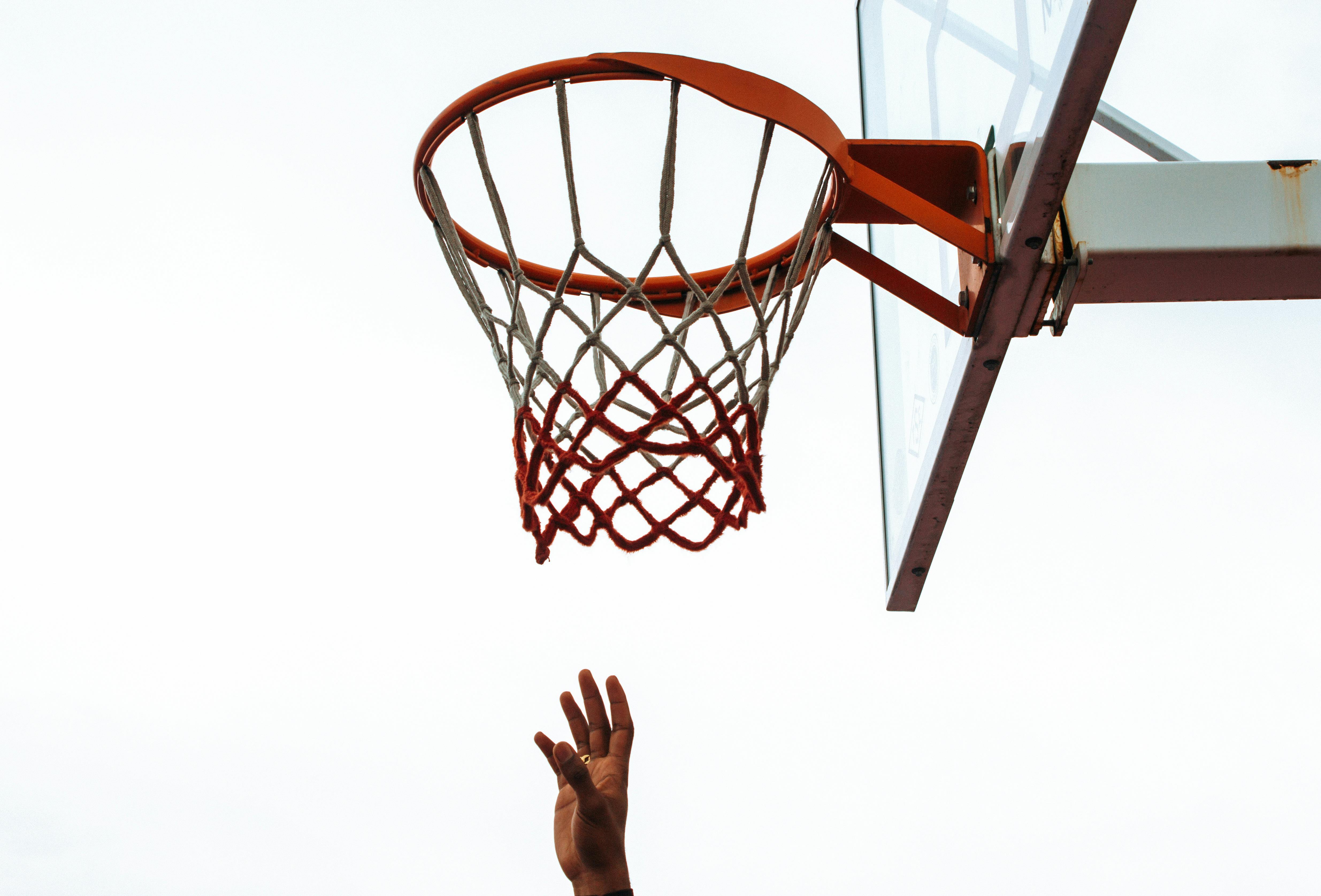 Hand Reaching for Basketball Hoop Shot Outdoors · Free Stock Photo