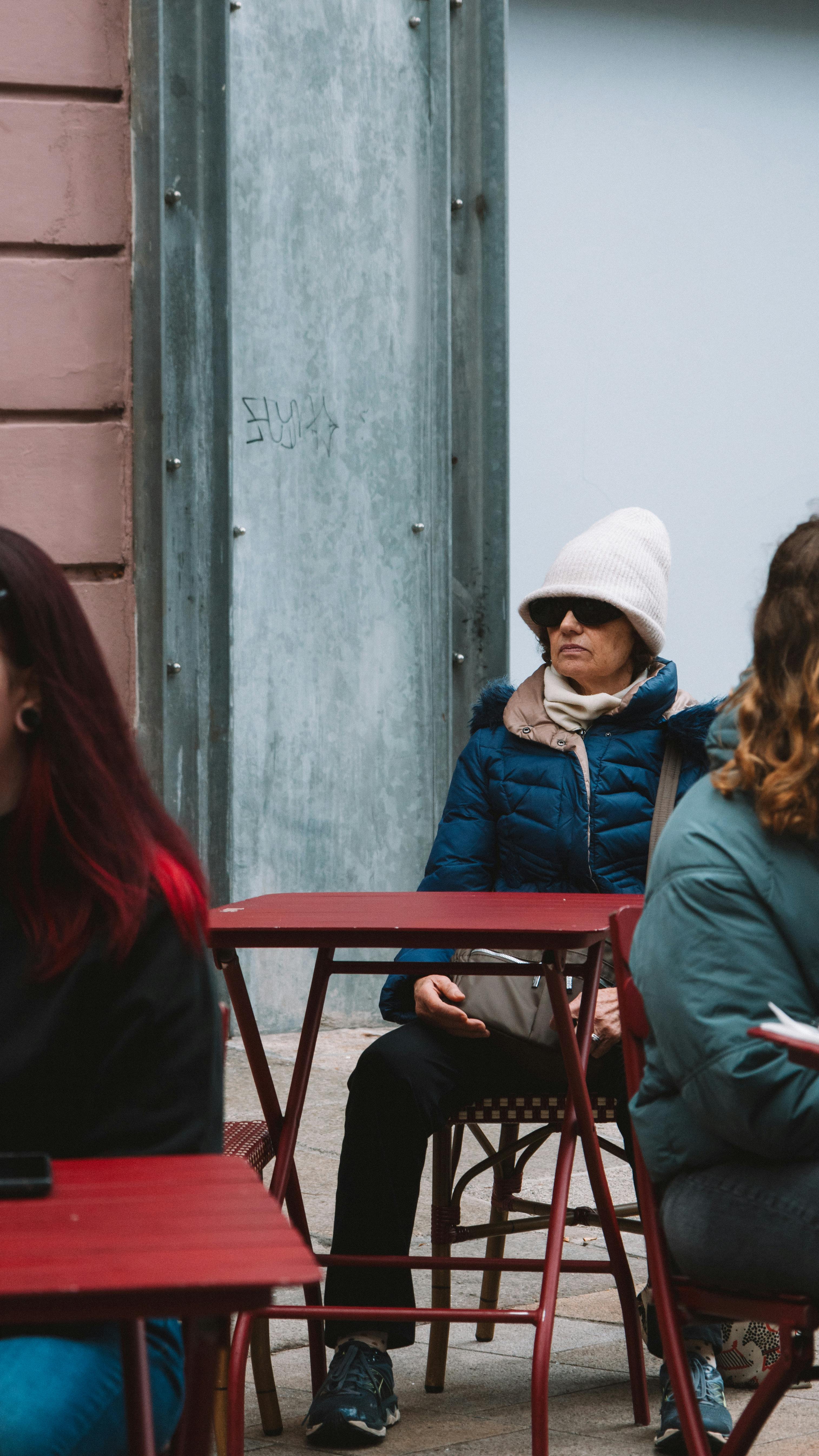 Casual Outdoor Café Scene with People in Jackets · Free Stock Photo