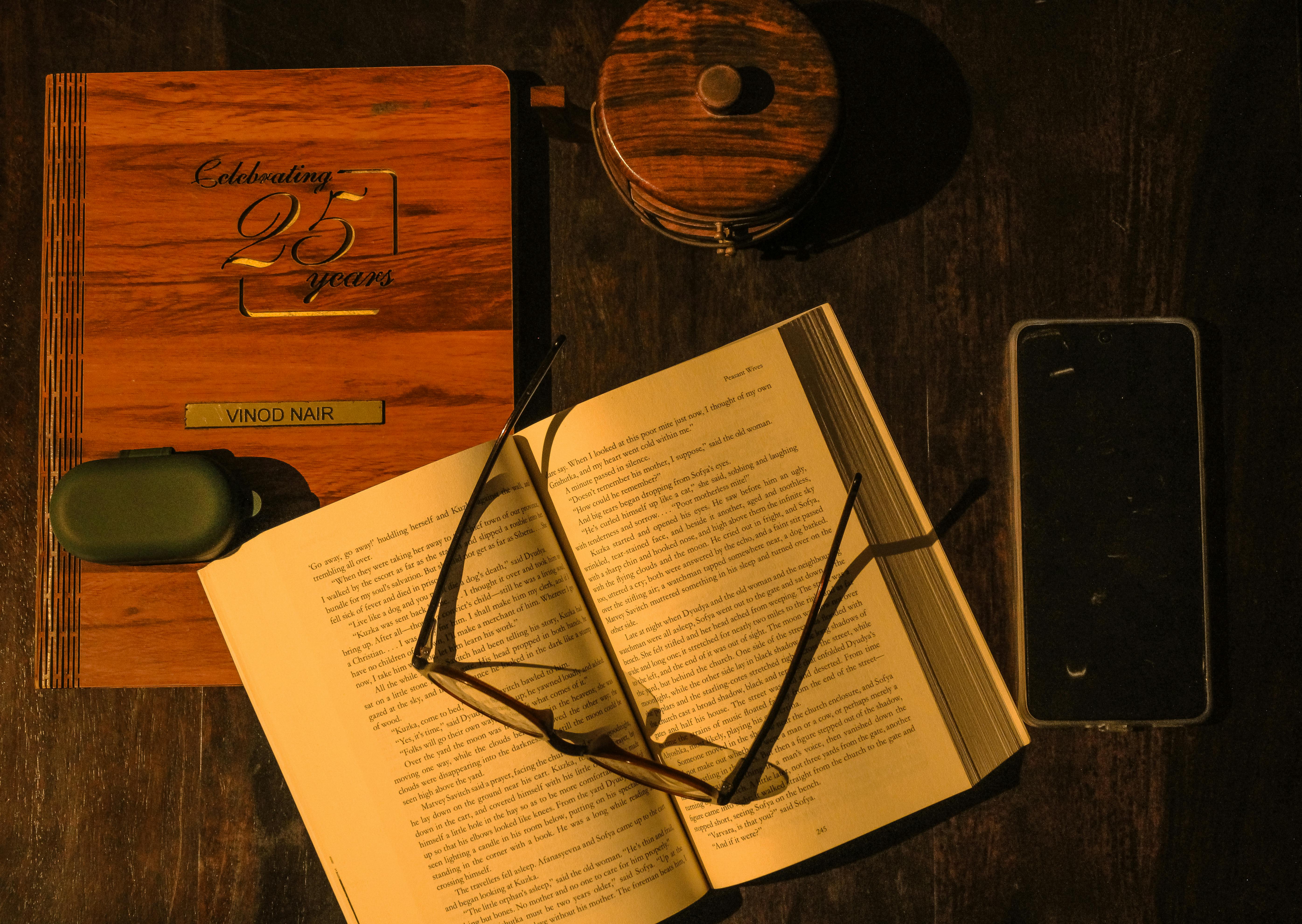 Cozy Reading Setup with Book and Glasses · Free Stock Photo