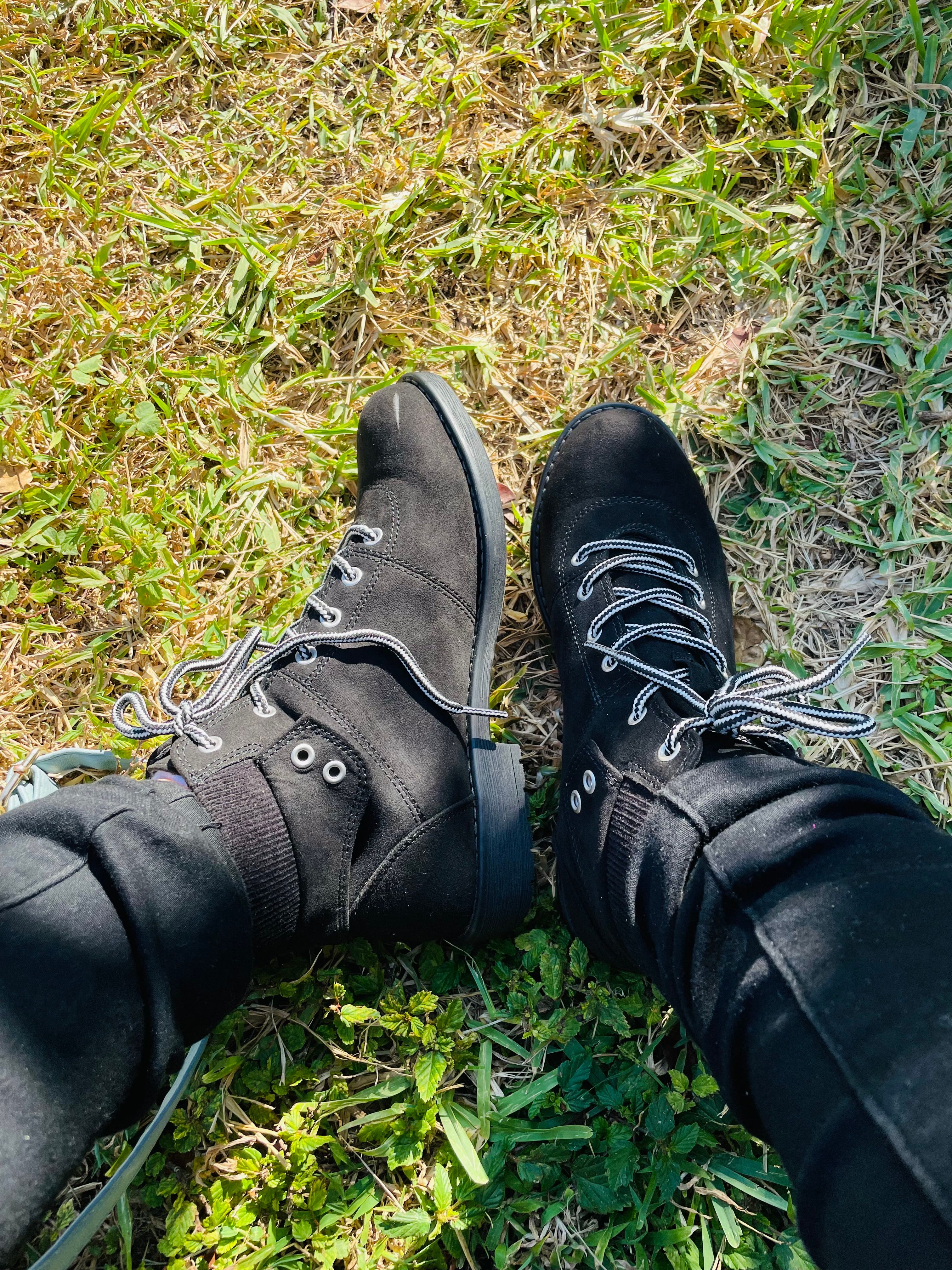 Black Boots on Grass: Relaxing Outdoor Style · Free Stock Photo
