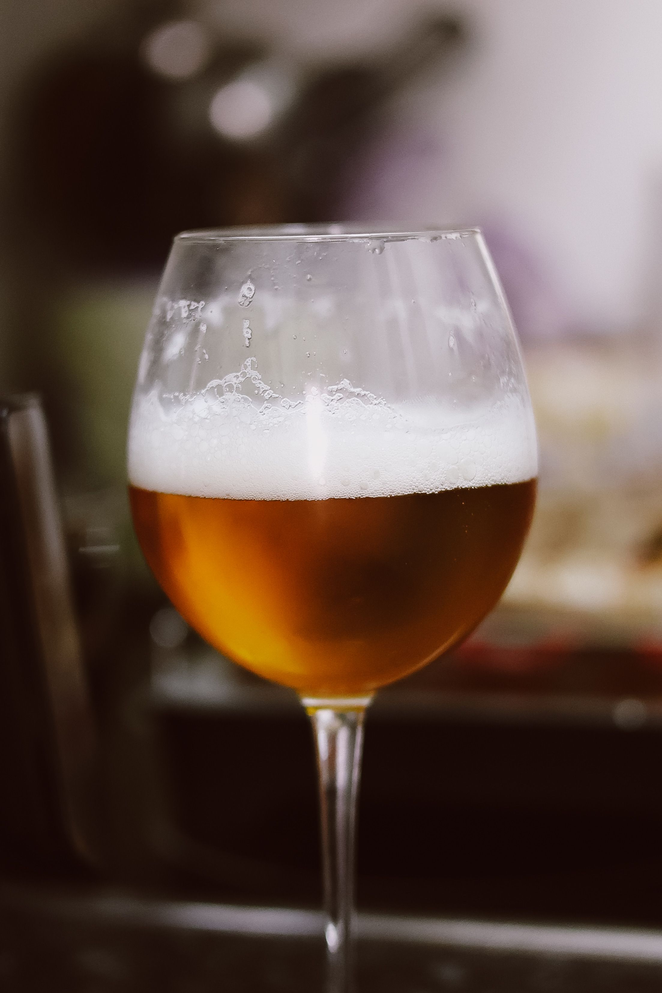 Close-Up of Beer Glass with Frothy Head · Free Stock Photo