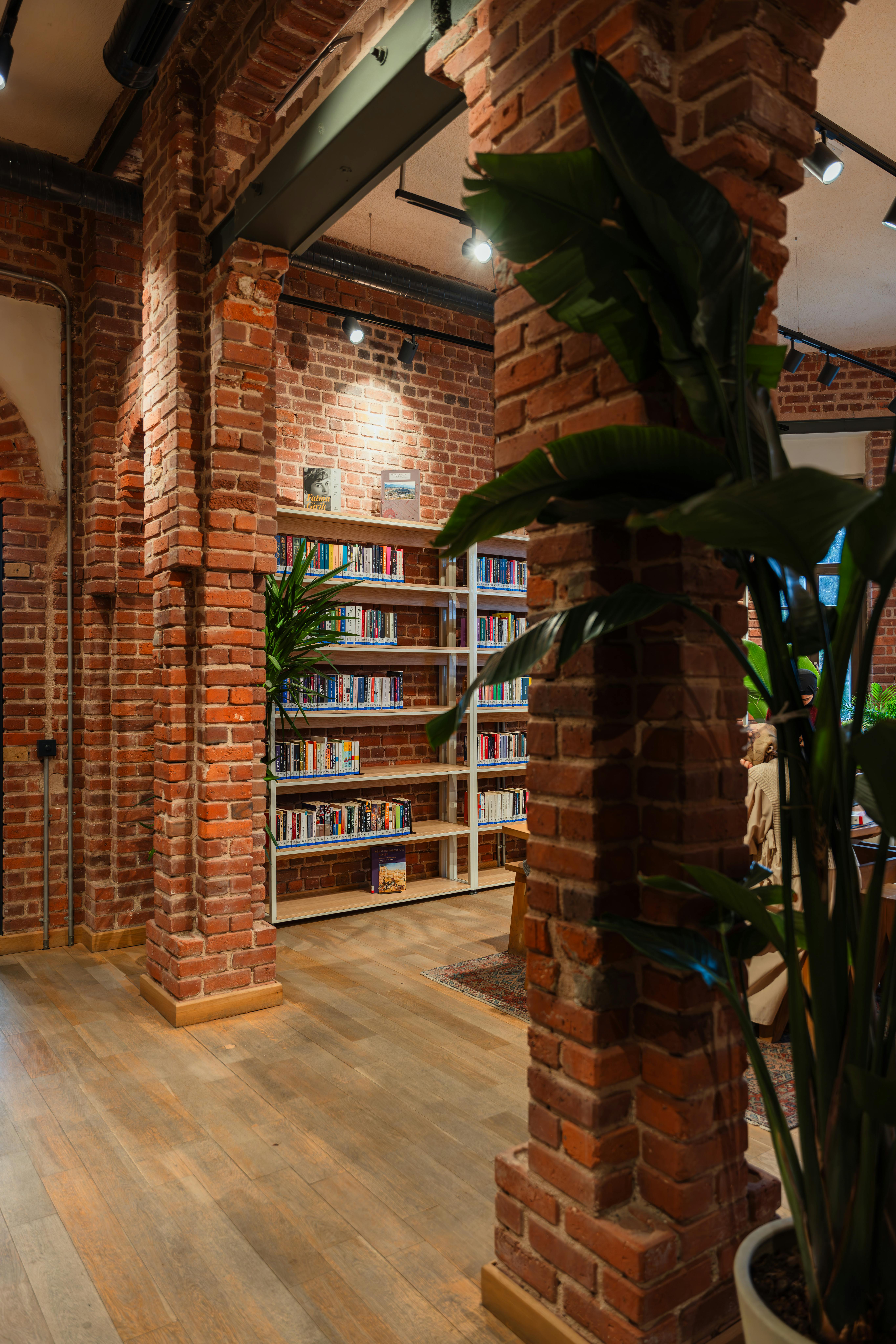 Cozy Industrial-Style Library with Exposed Brick · Free Stock Photo