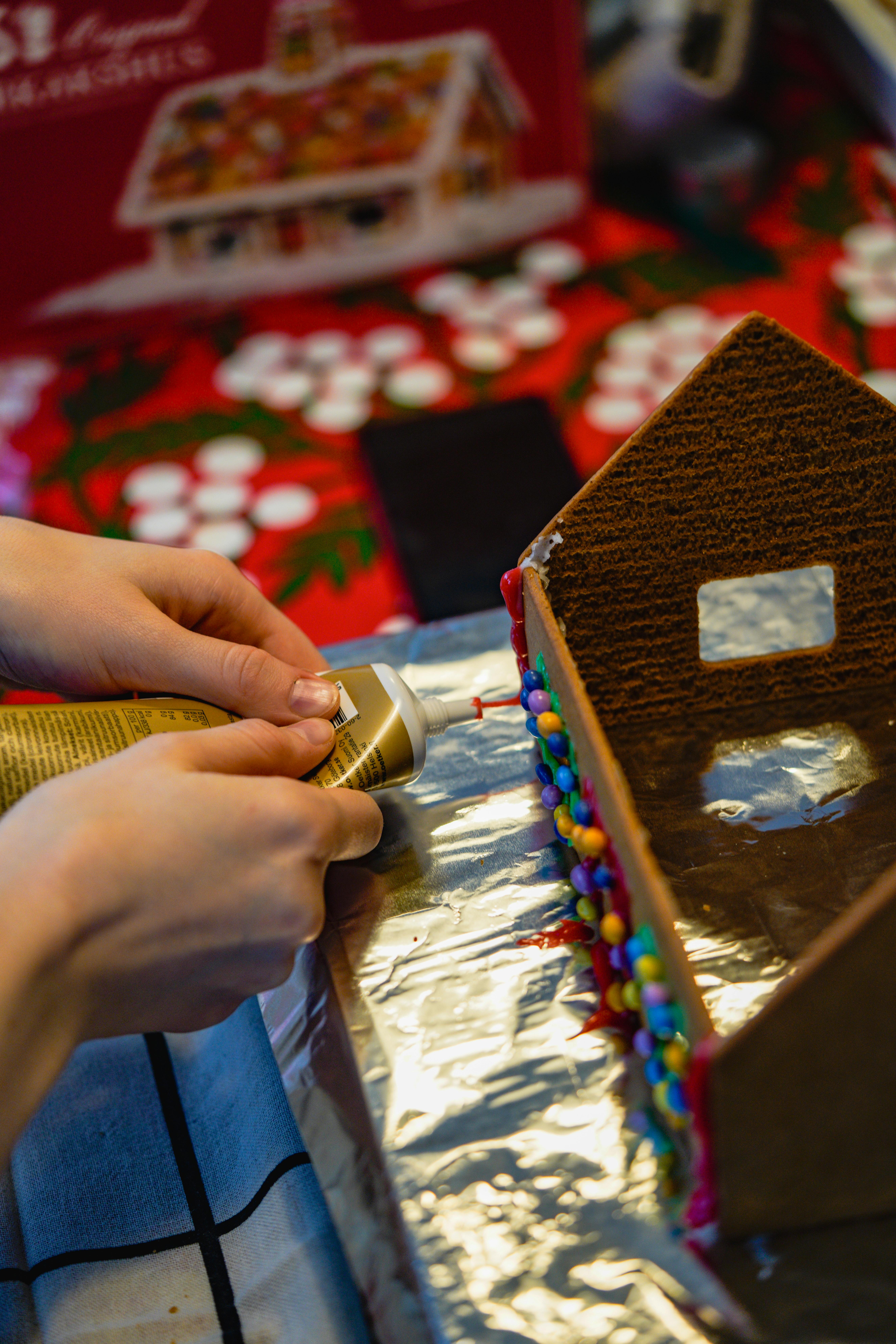 Building a Festive Gingerbread House for Christmas · Free Stock Photo