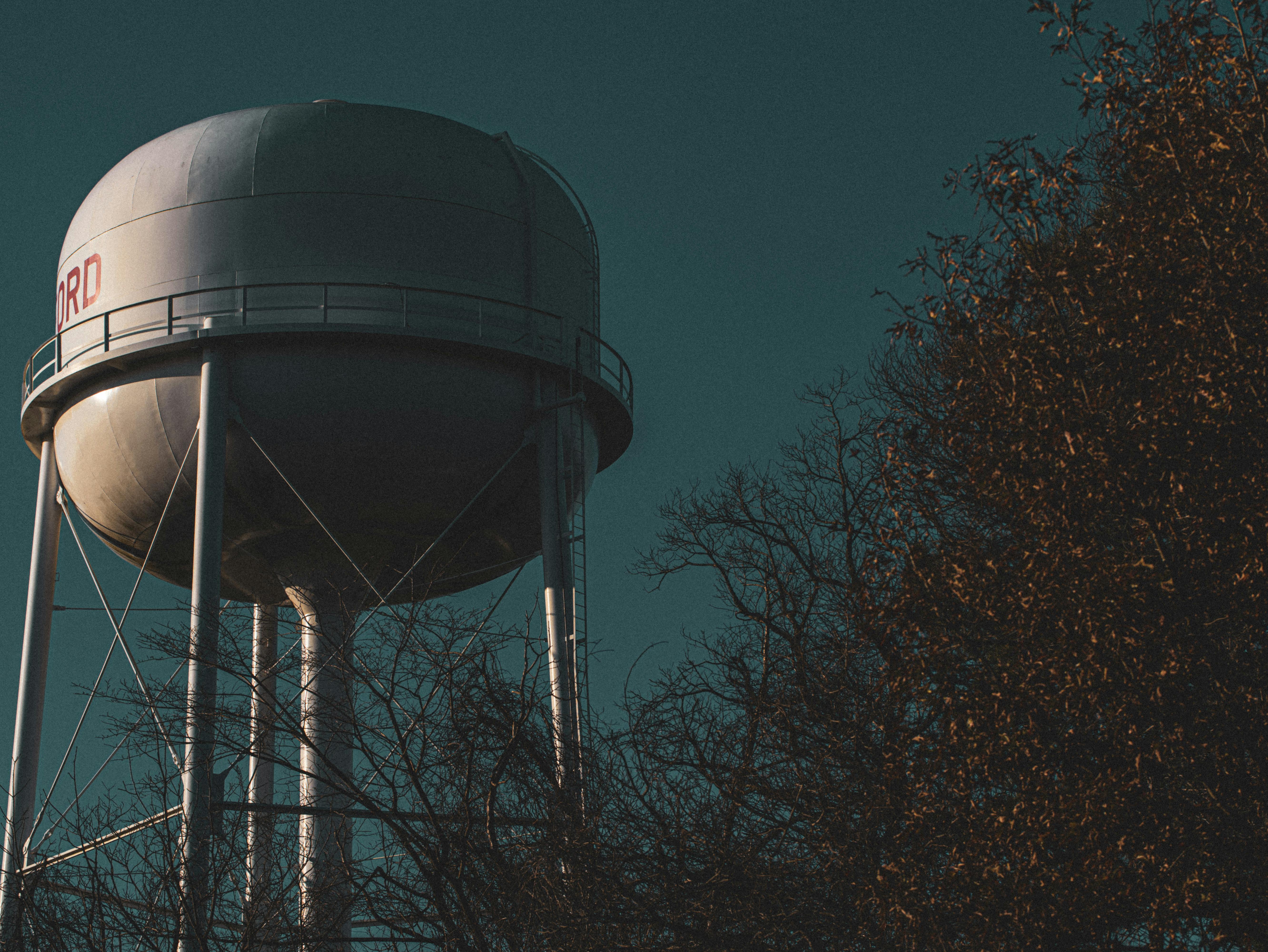Industrial Water Tower Against Dramatic Sky · Free Stock Photo