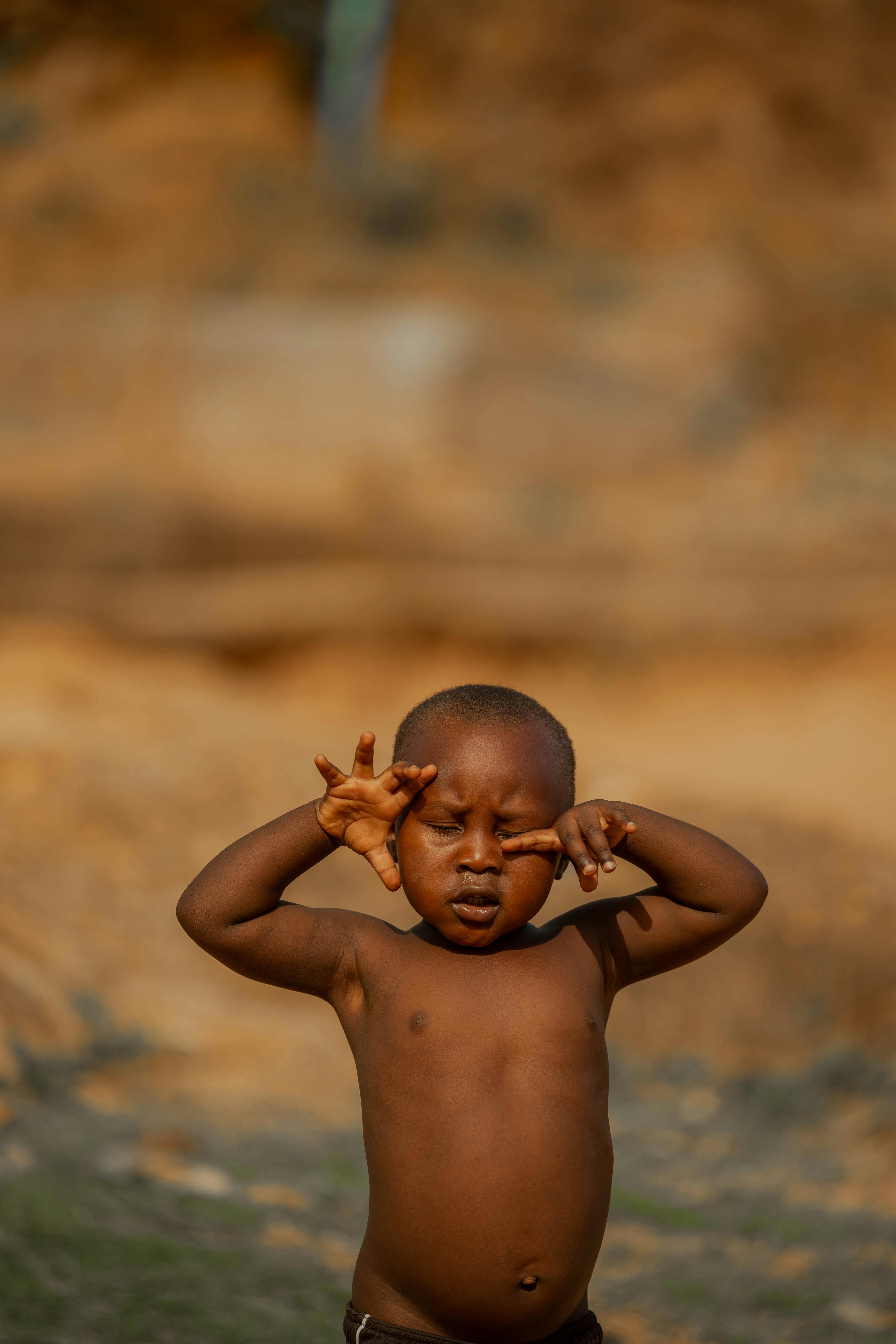 Joyful African Child Playing Outdoors in Nigeria · Free Stock Photo
