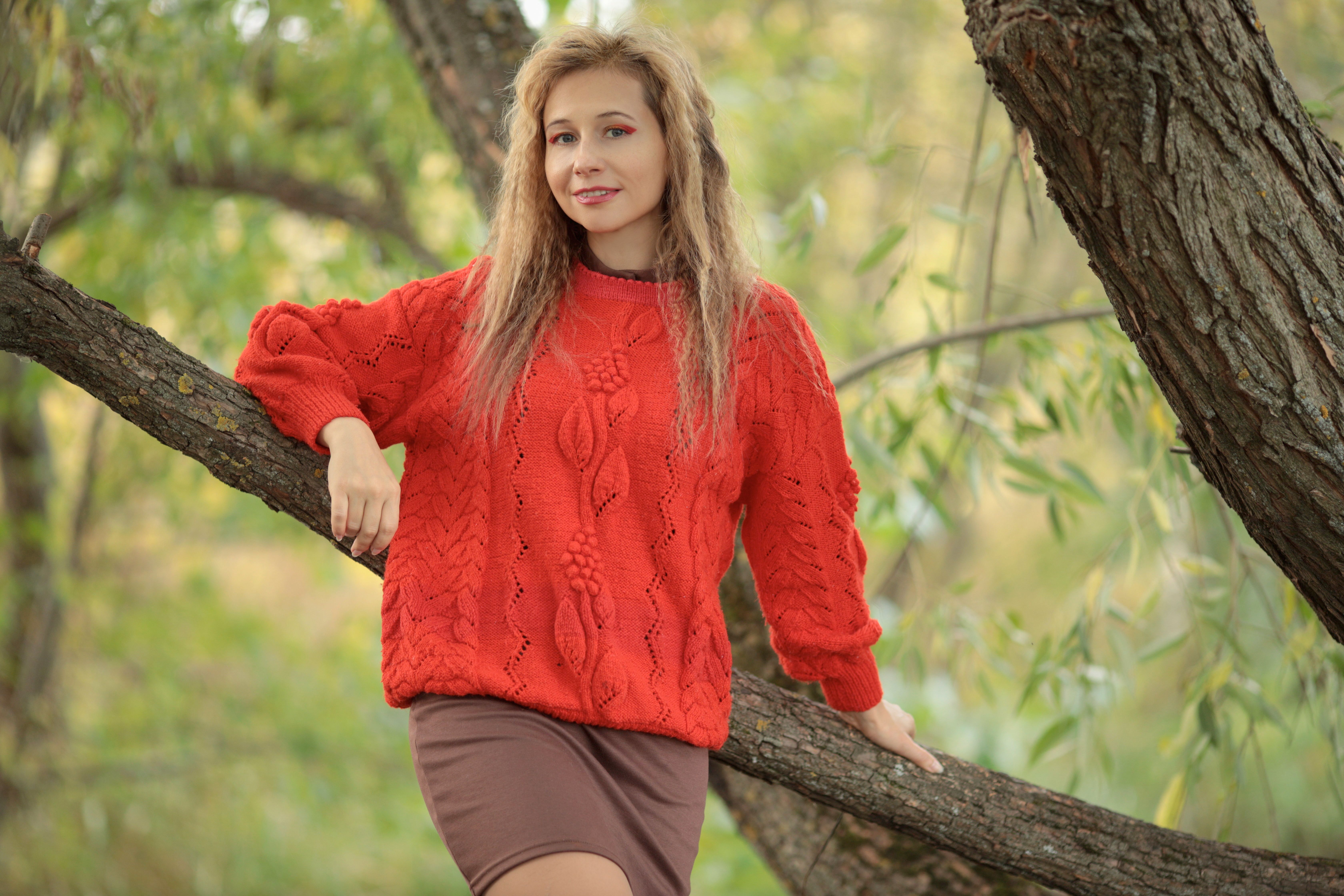 Young Woman in Red Sweater Posing Outdoors · Free Stock Photo
