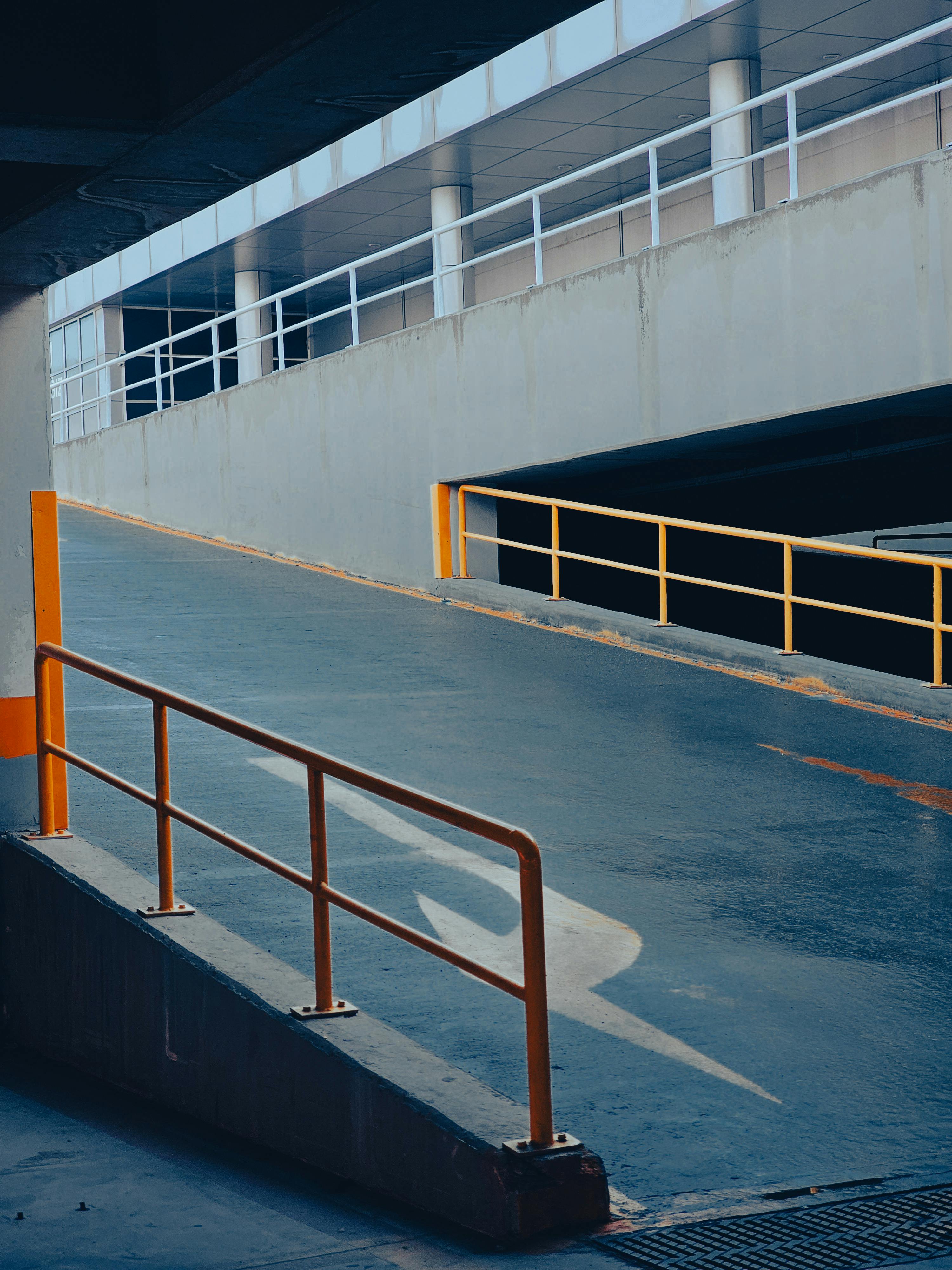 Modern city parking lot ramp with railings · Free Stock Photo