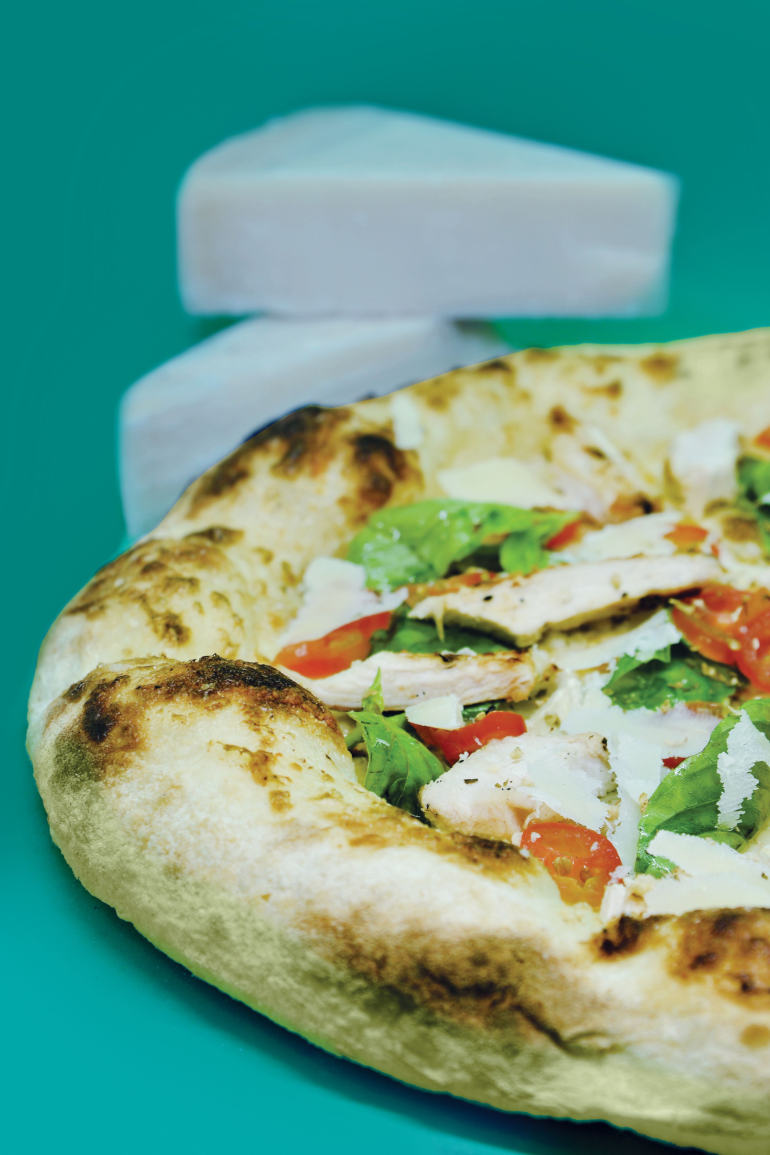 Close-up of Gourmet Pizza with Cheese Blocks · Free Stock Photo