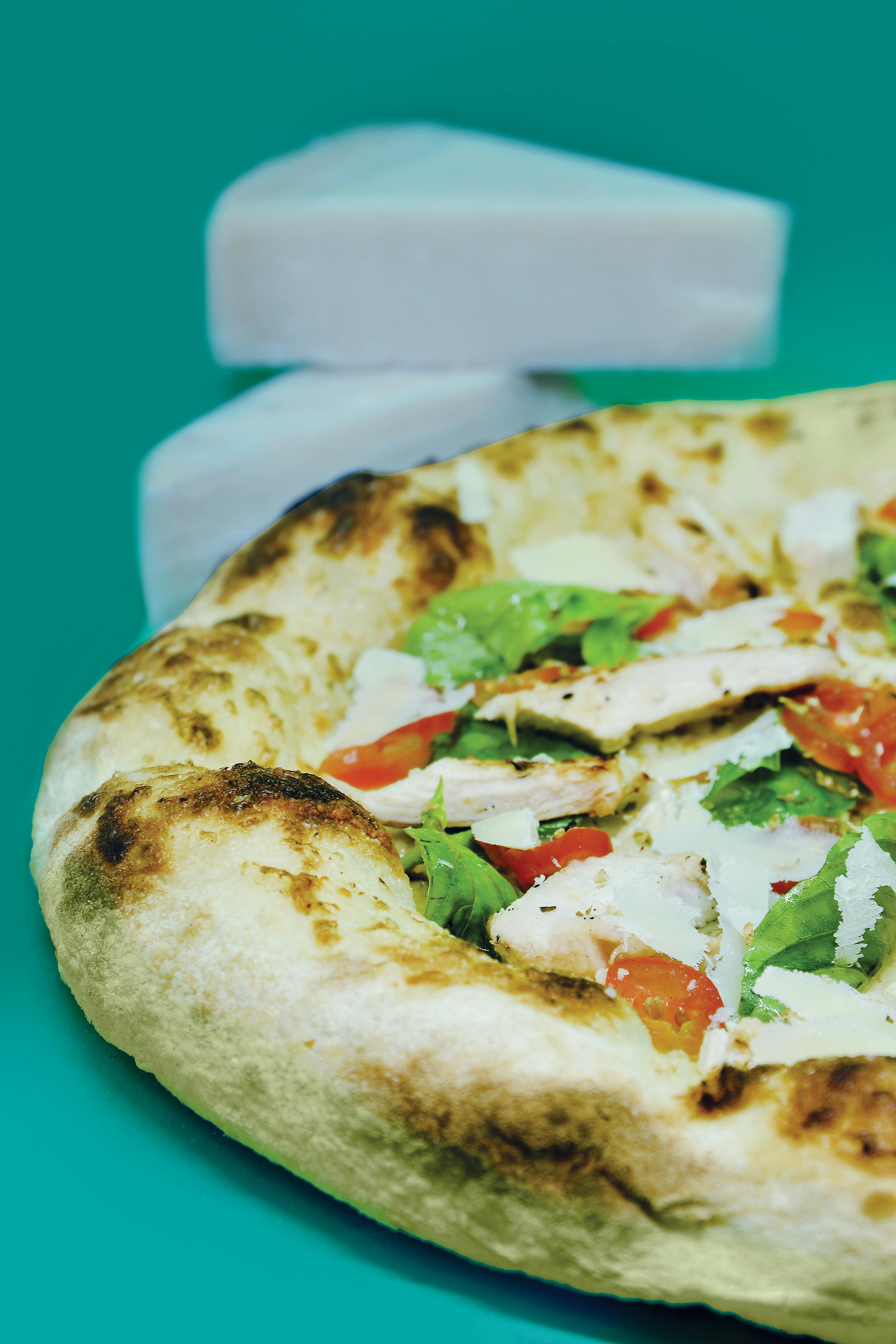 Close-up of Gourmet Pizza with Cheese Blocks · Free Stock Photo