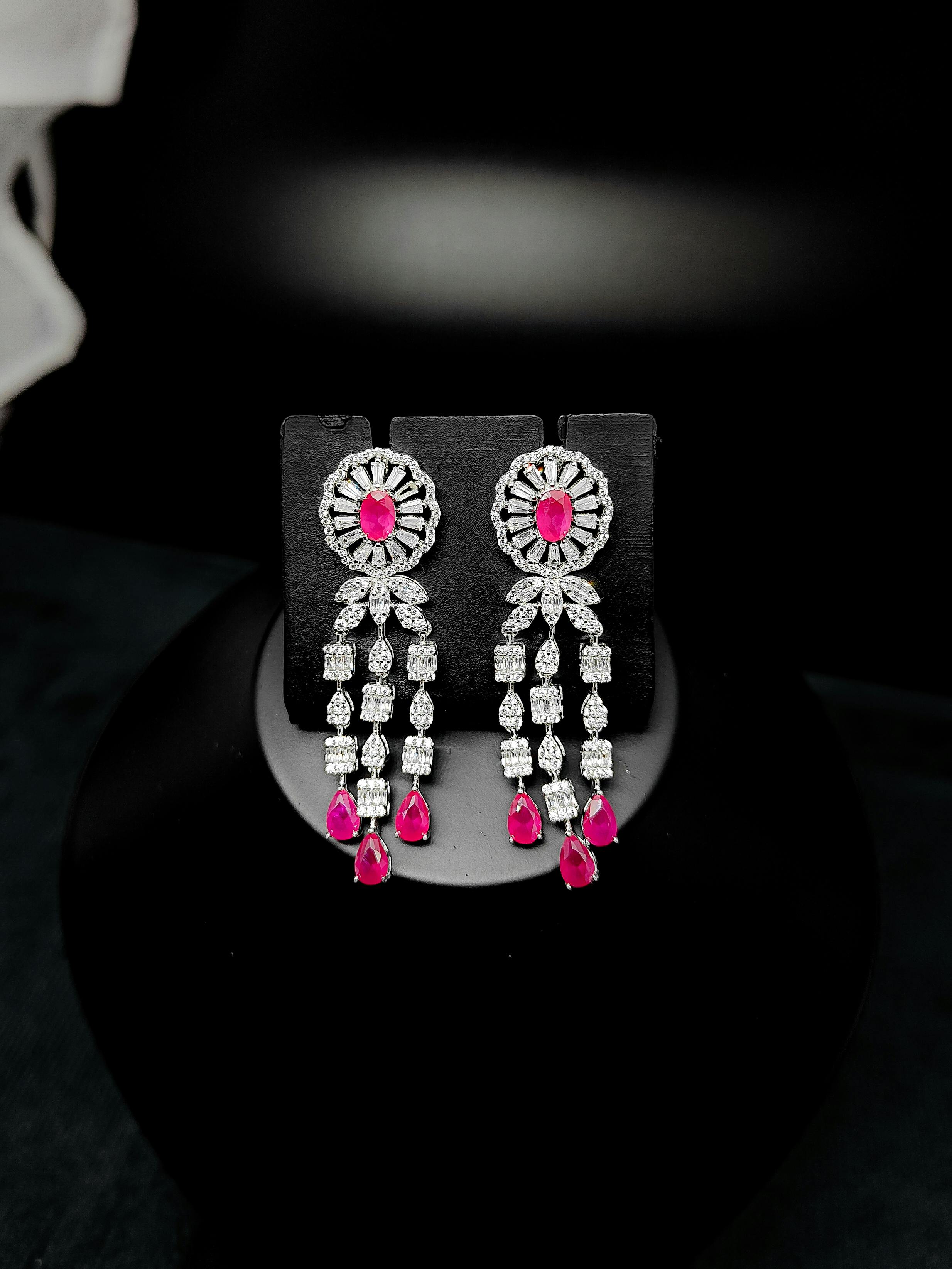 Elegant Silver and Ruby Dangling Earrings Display · Free Stock Photo