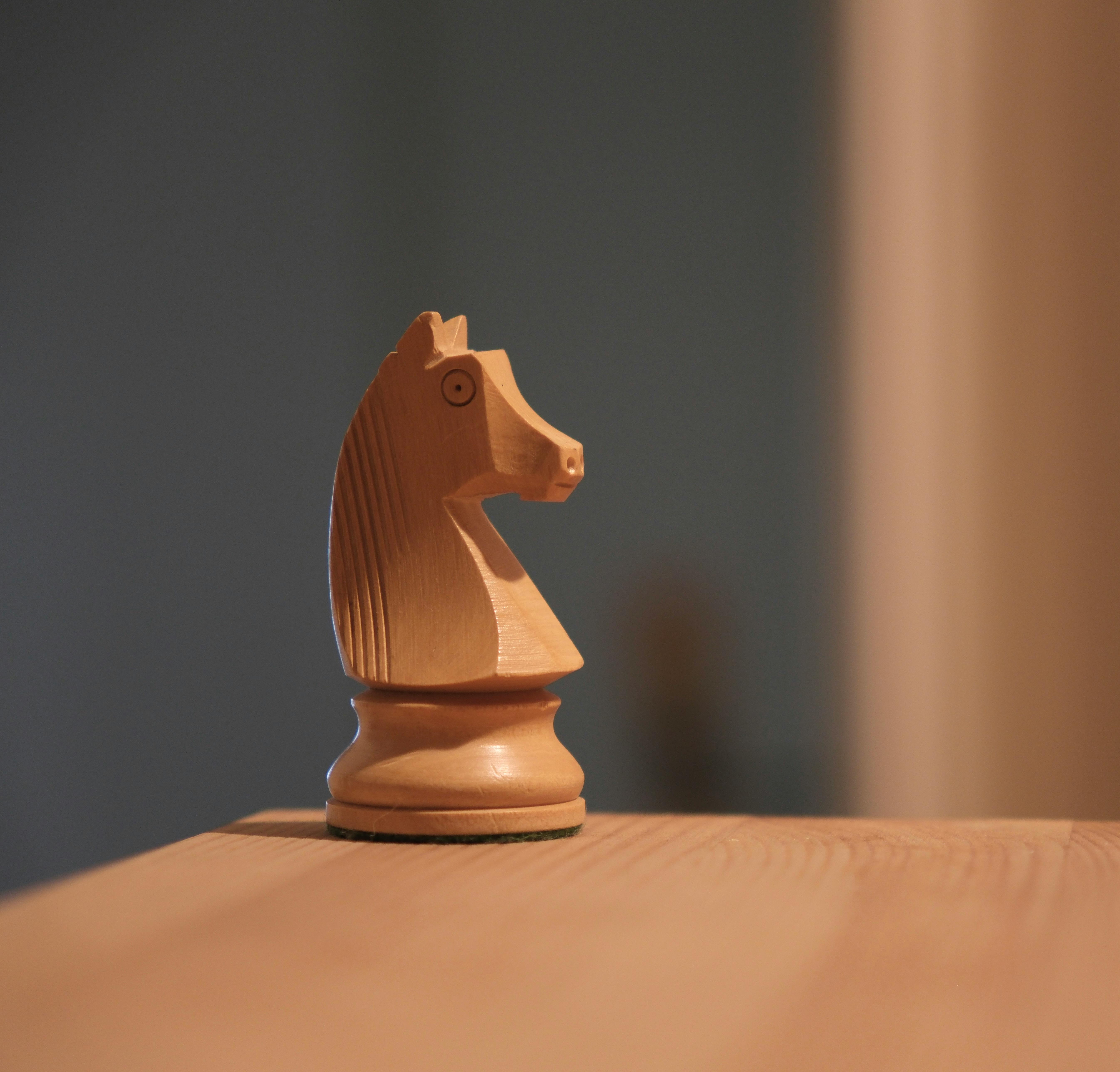 Wooden Knight Chess Piece on Wooden Table · Free Stock Photo