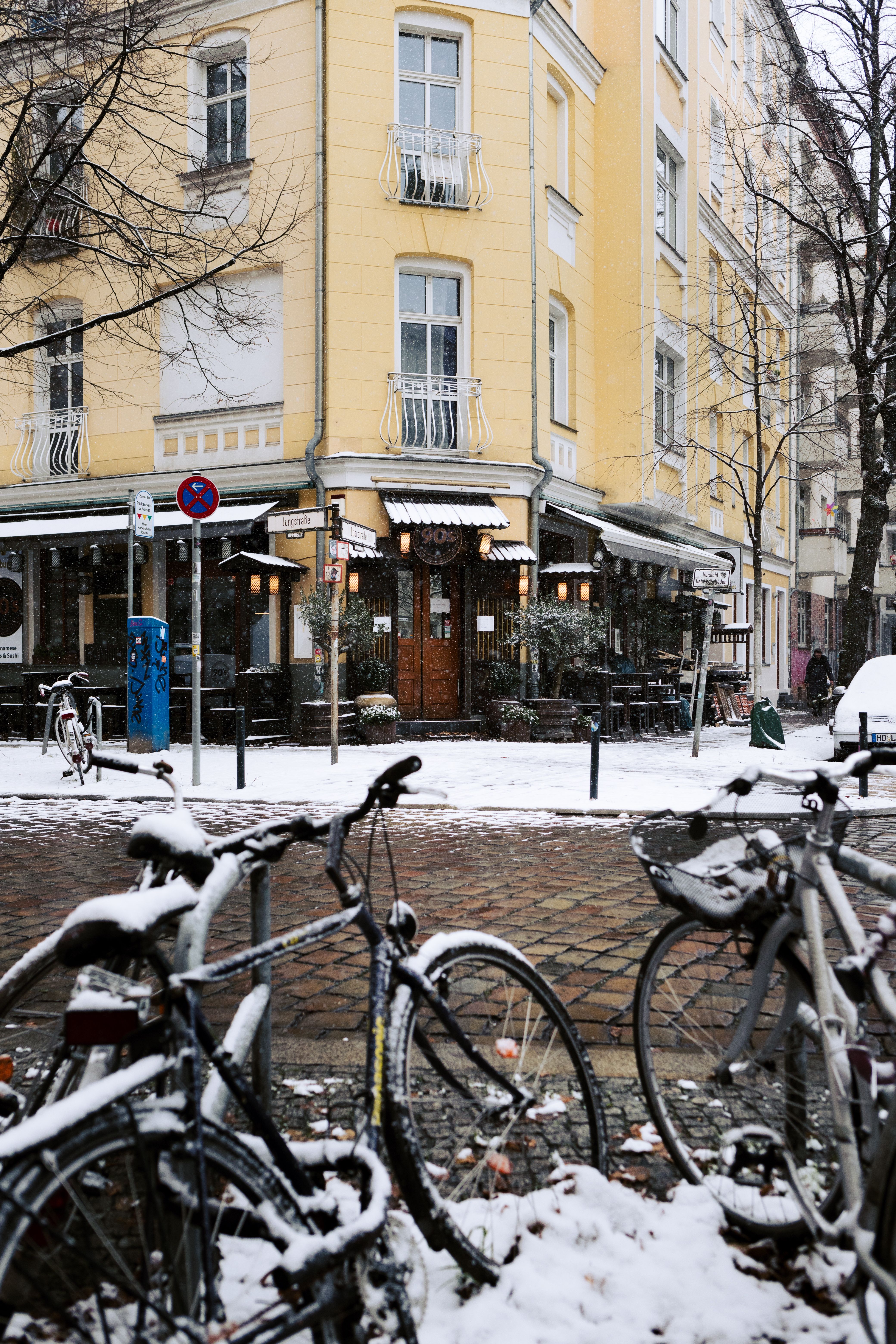 Snowy Berlin Street with Yellow Apartment Building · Free Stock Photo