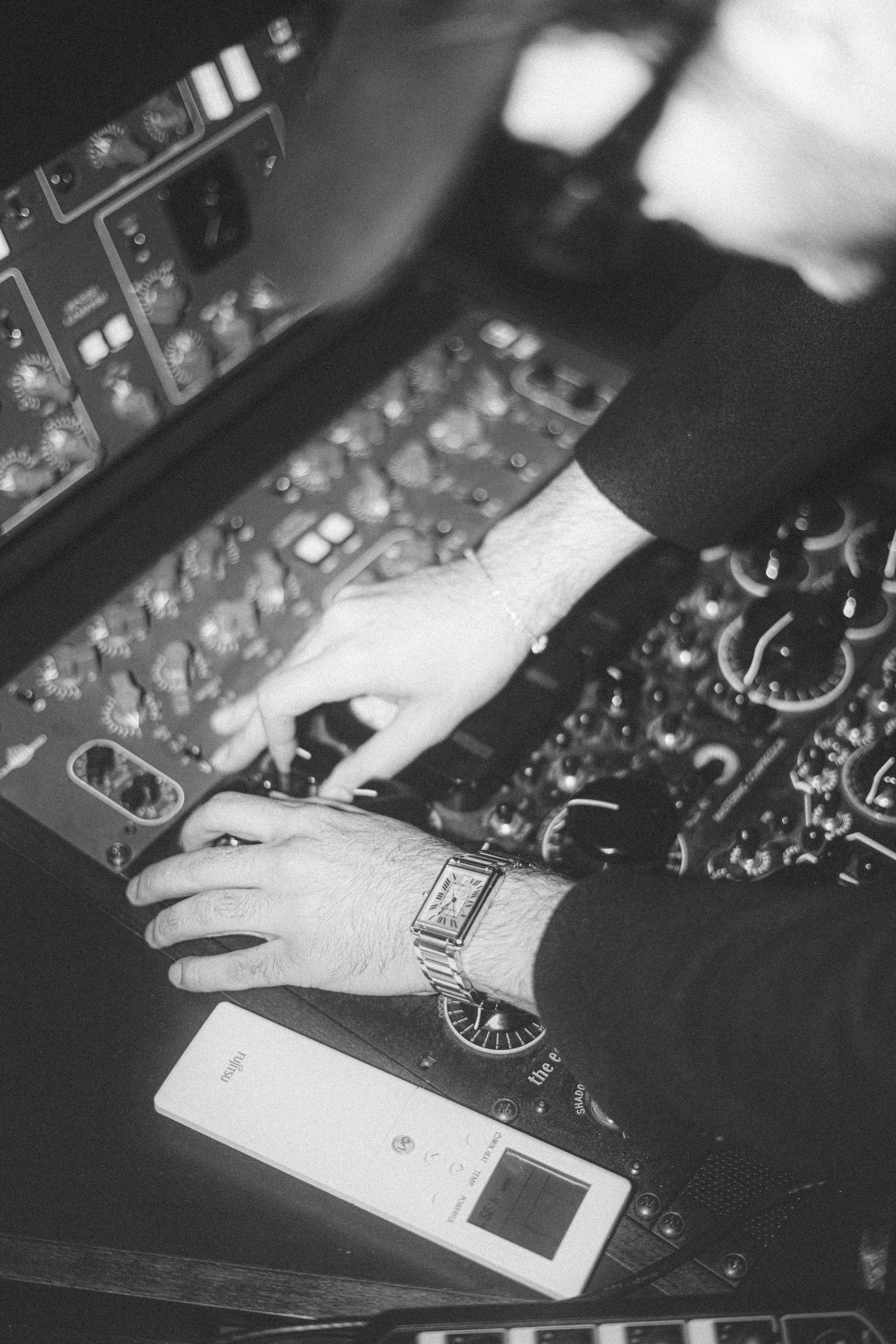 Pilot Adjusting Controls in Airplane Cockpit · Free Stock Photo