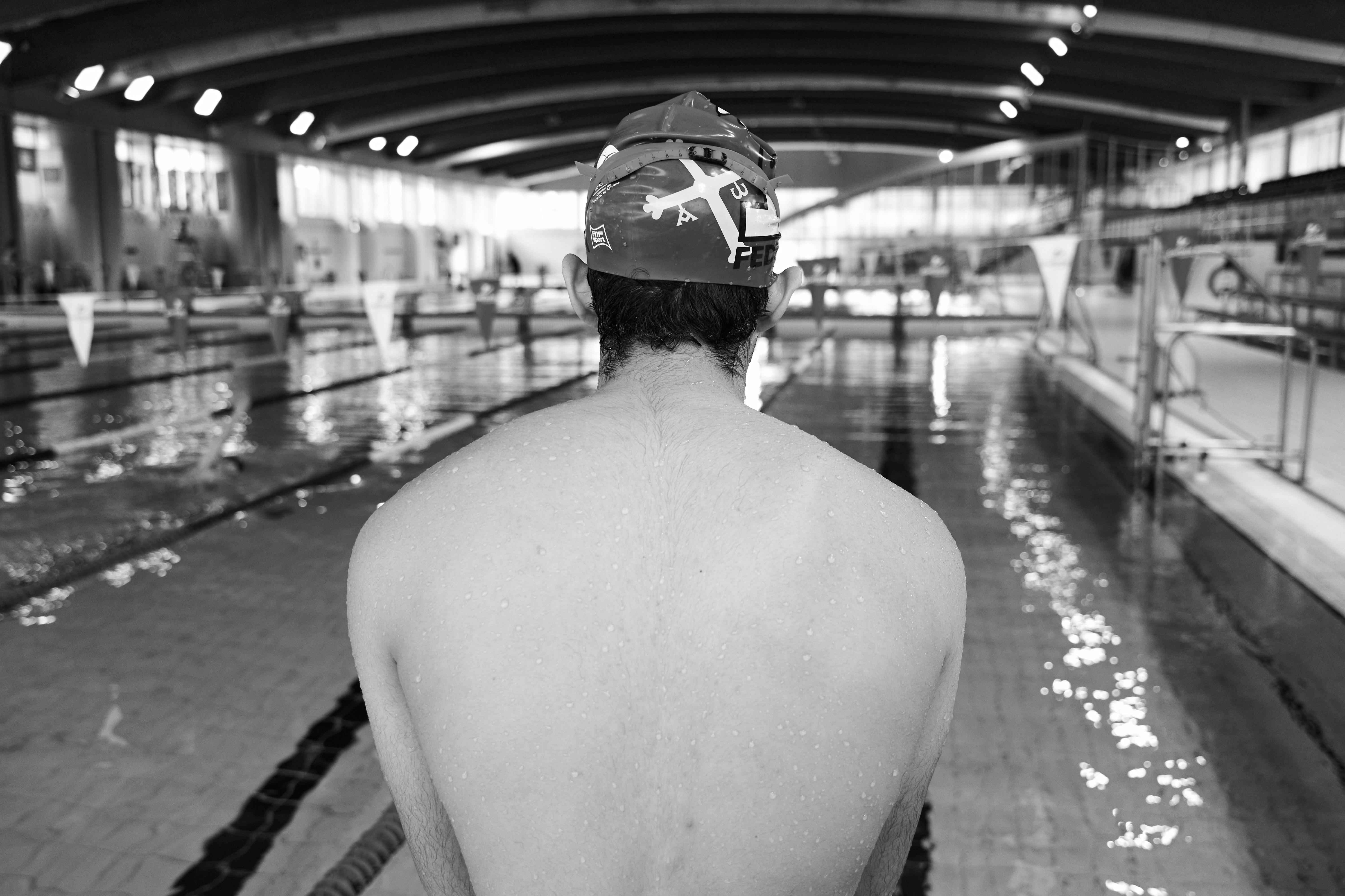 Rear View of Swimmer Preparing at Indoor Pool · Free Stock Photo