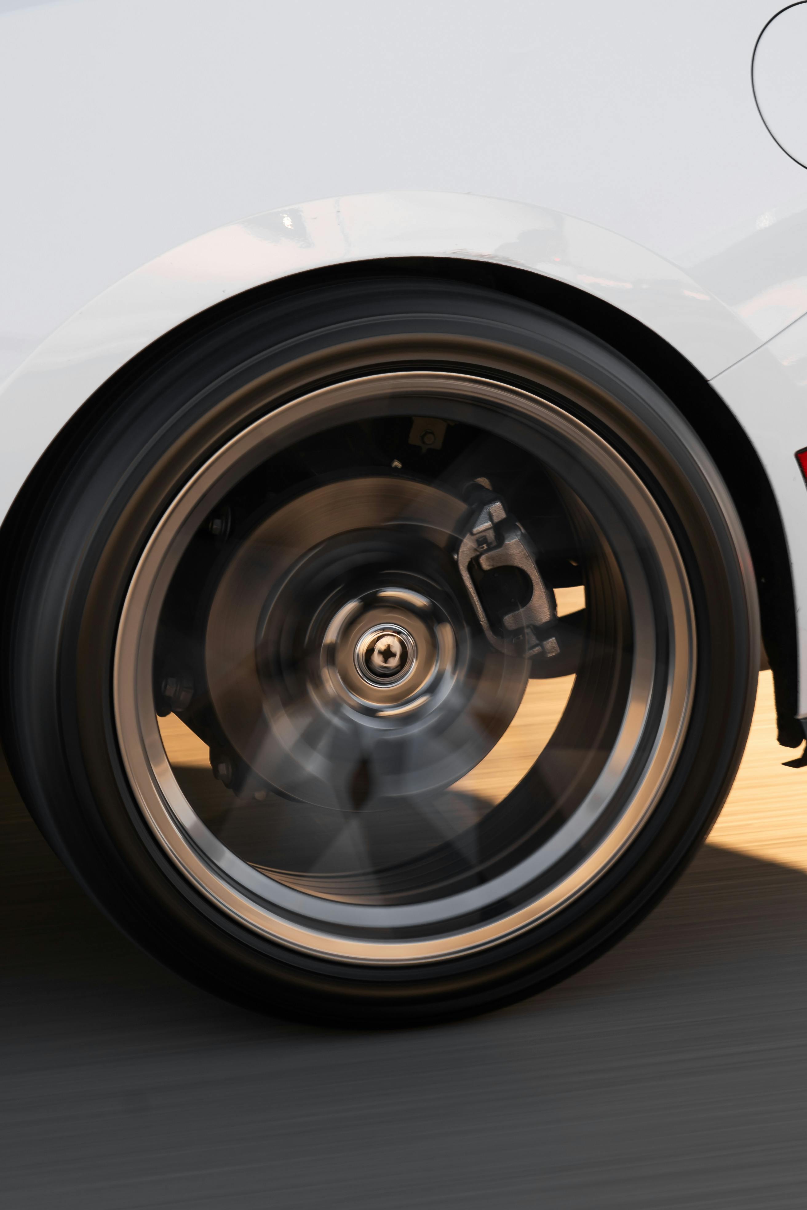 Dynamic Close-Up of a Spinning Car Wheel · Free Stock Photo