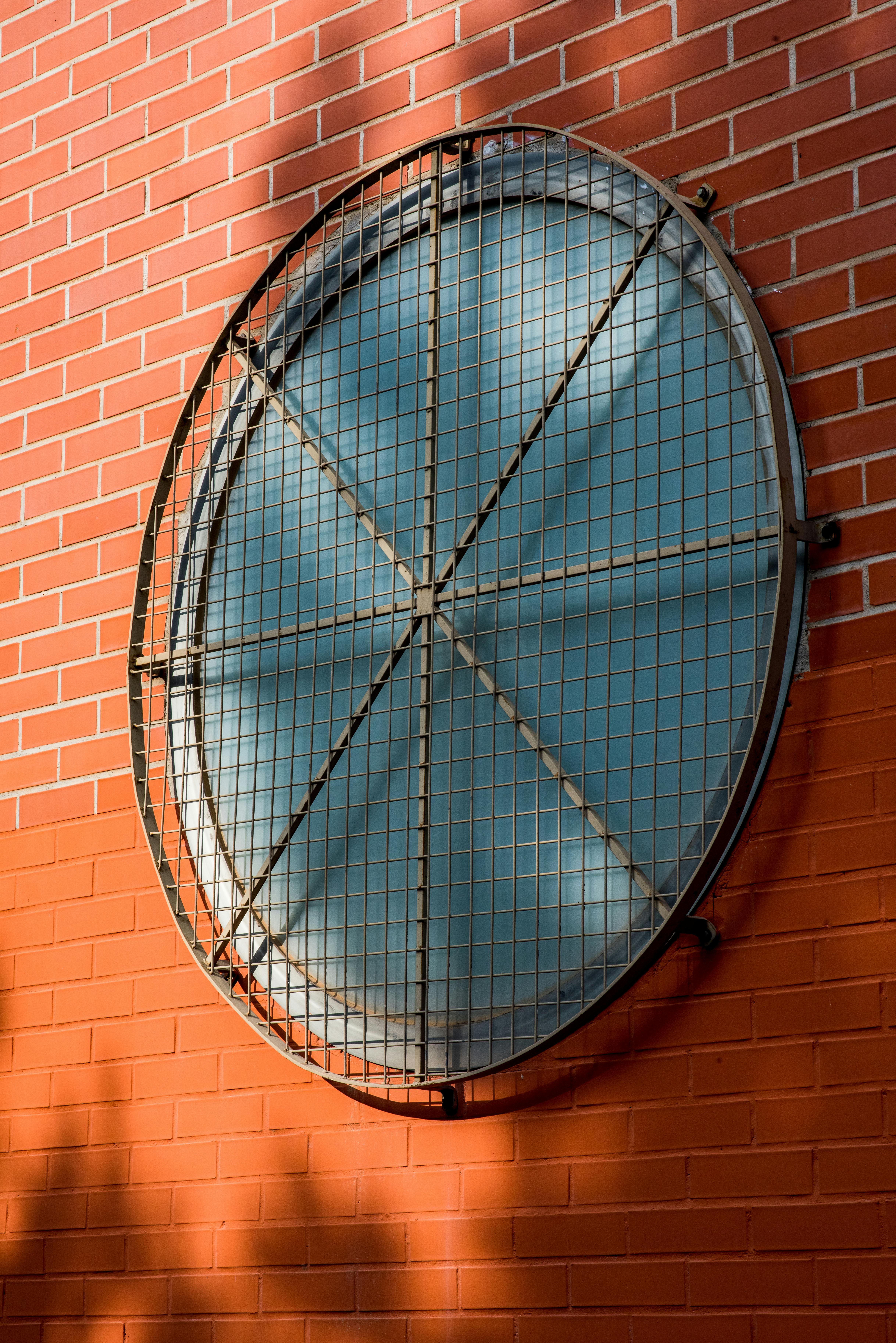 Circular Metal Grate on Red Brick Wall · Free Stock Photo
