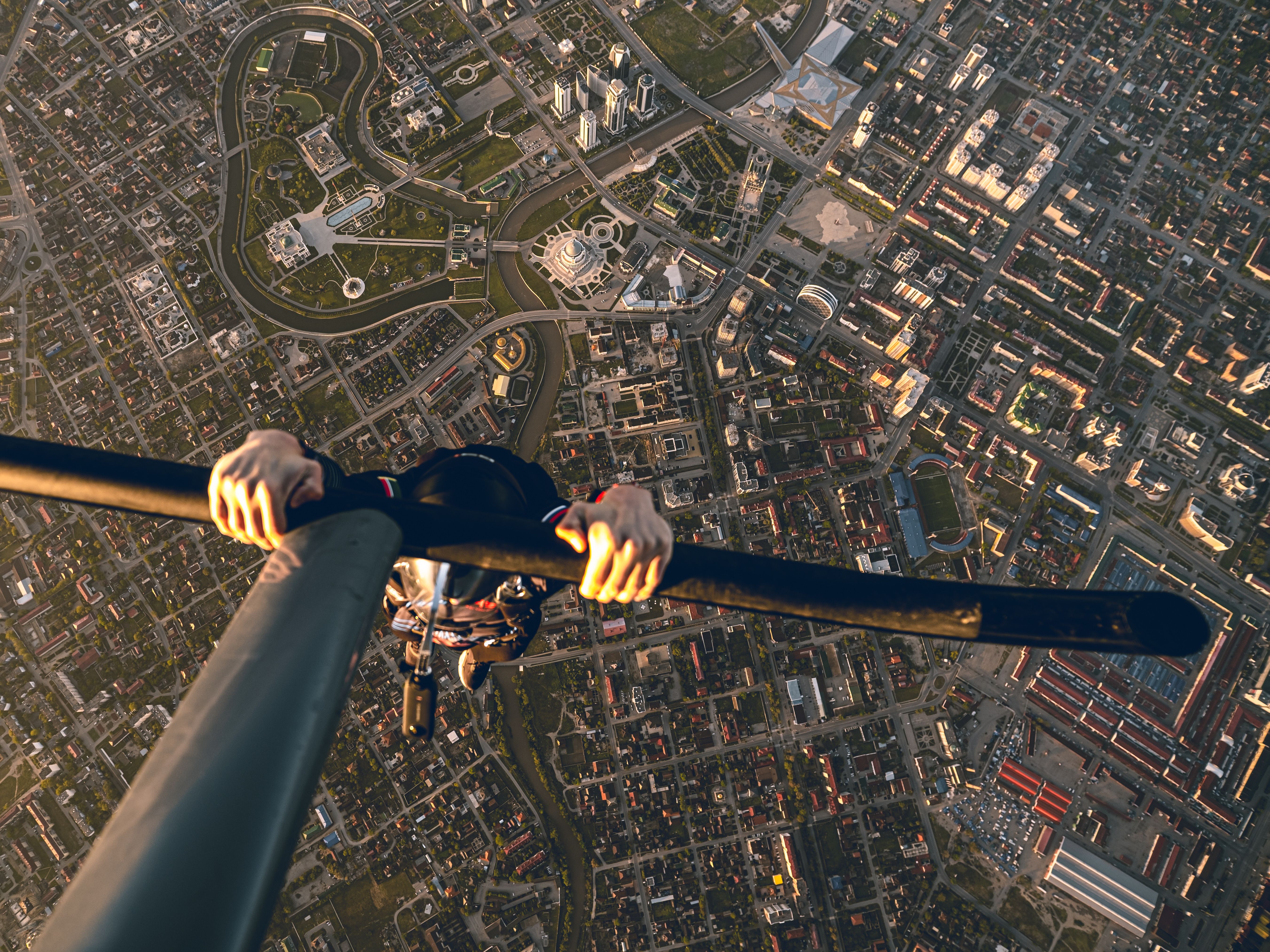 Daring aerial stunt over a bustling cityscape · Free Stock Photo