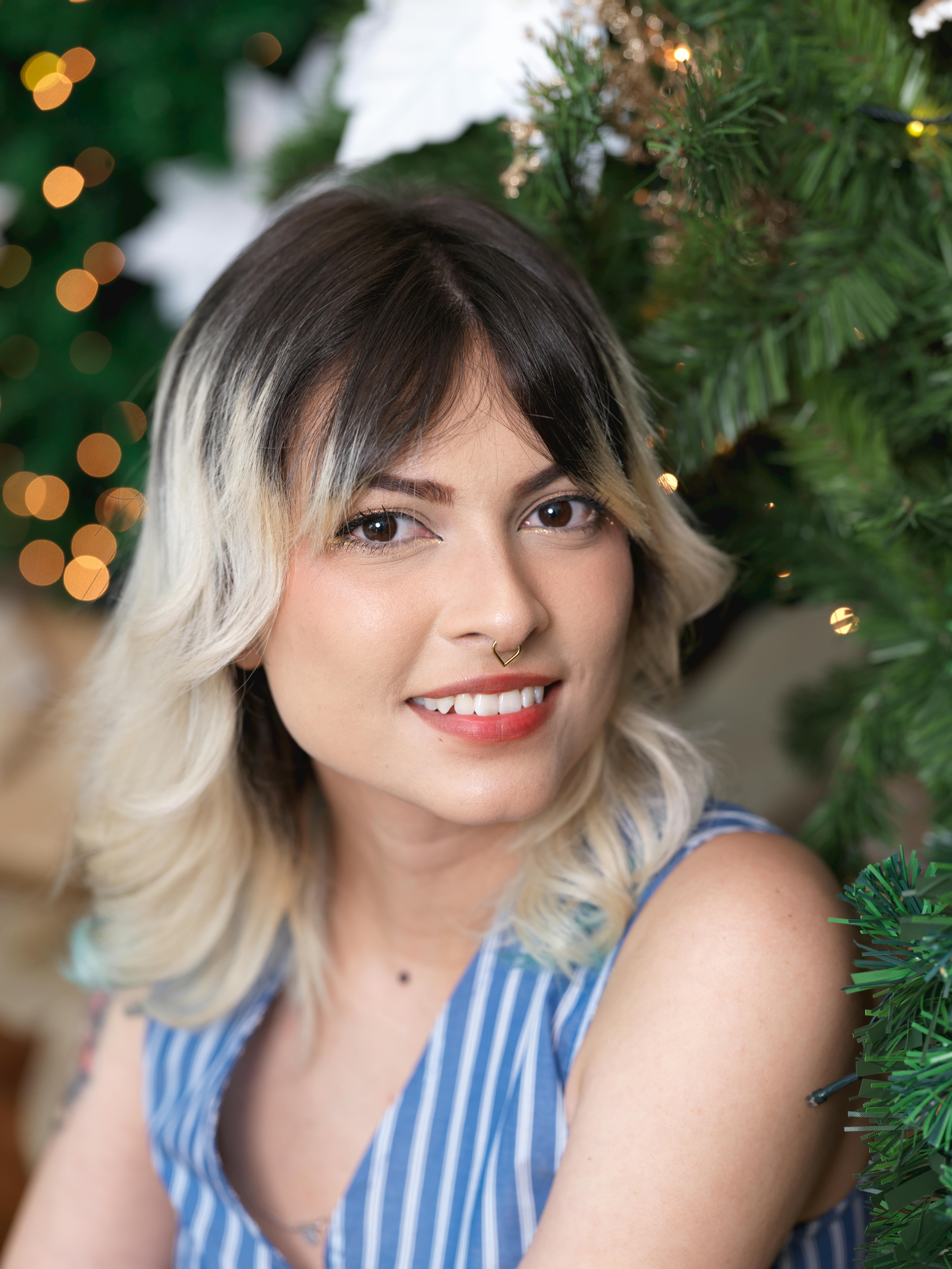Festive Portrait of Smiling Woman by Christmas Tree · Free Stock Photo
