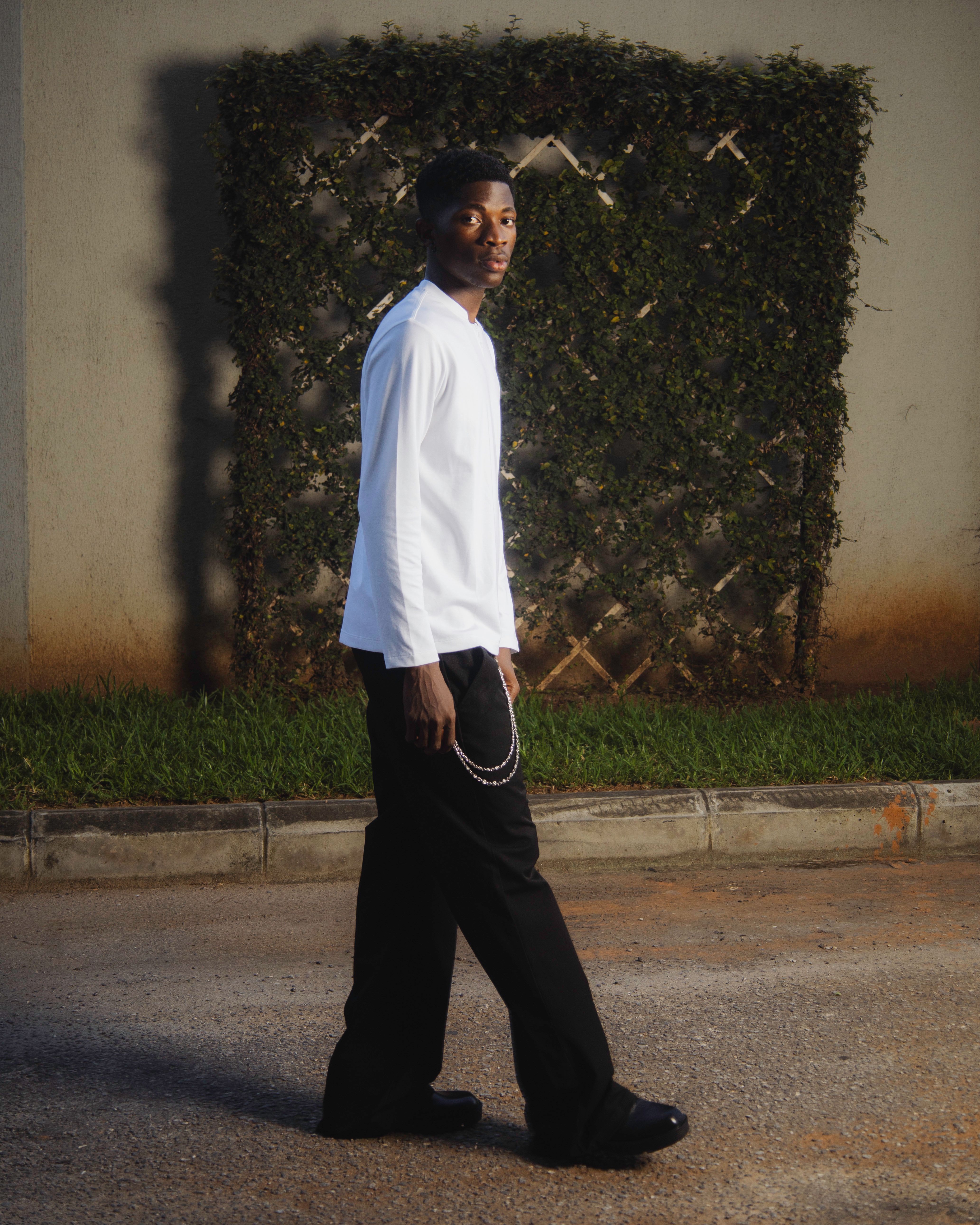 Stylish Young Man Walking Outdoors in Urban Setting · Free Stock Photo