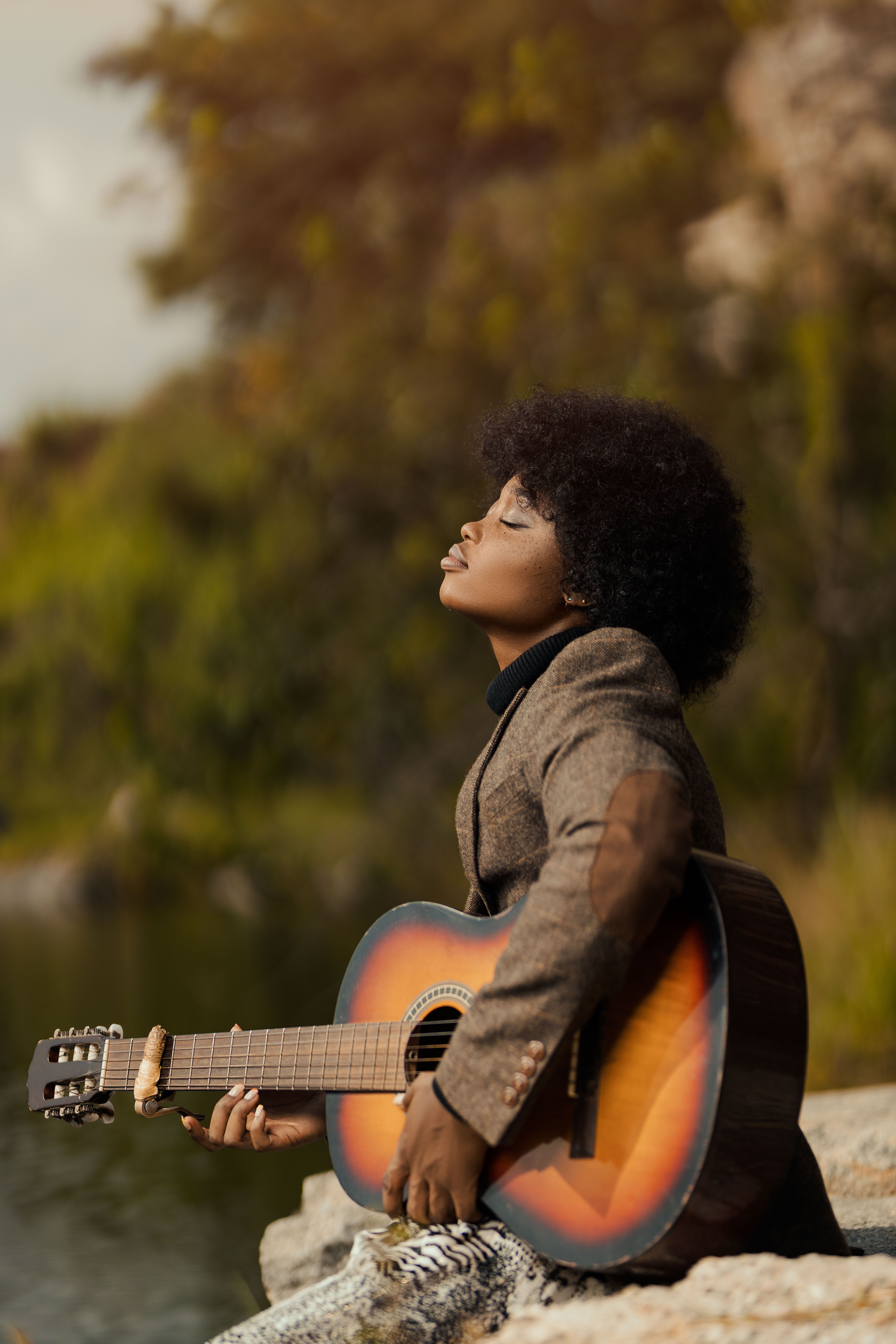Serene Outdoor Portrait with Acoustic Guitar · Free Stock Photo