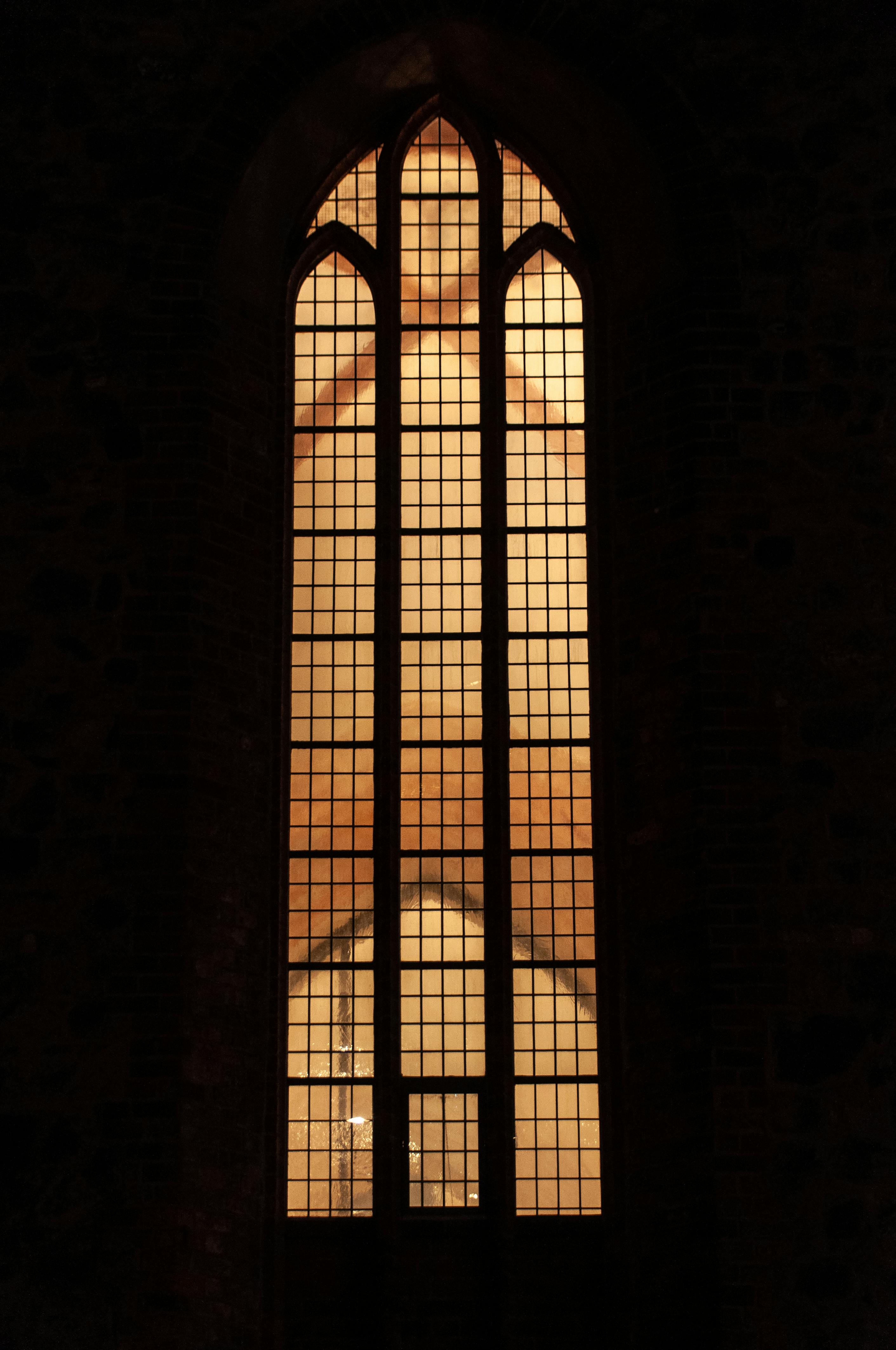 Gothic Arch Window Illuminated at Night · Free Stock Photo