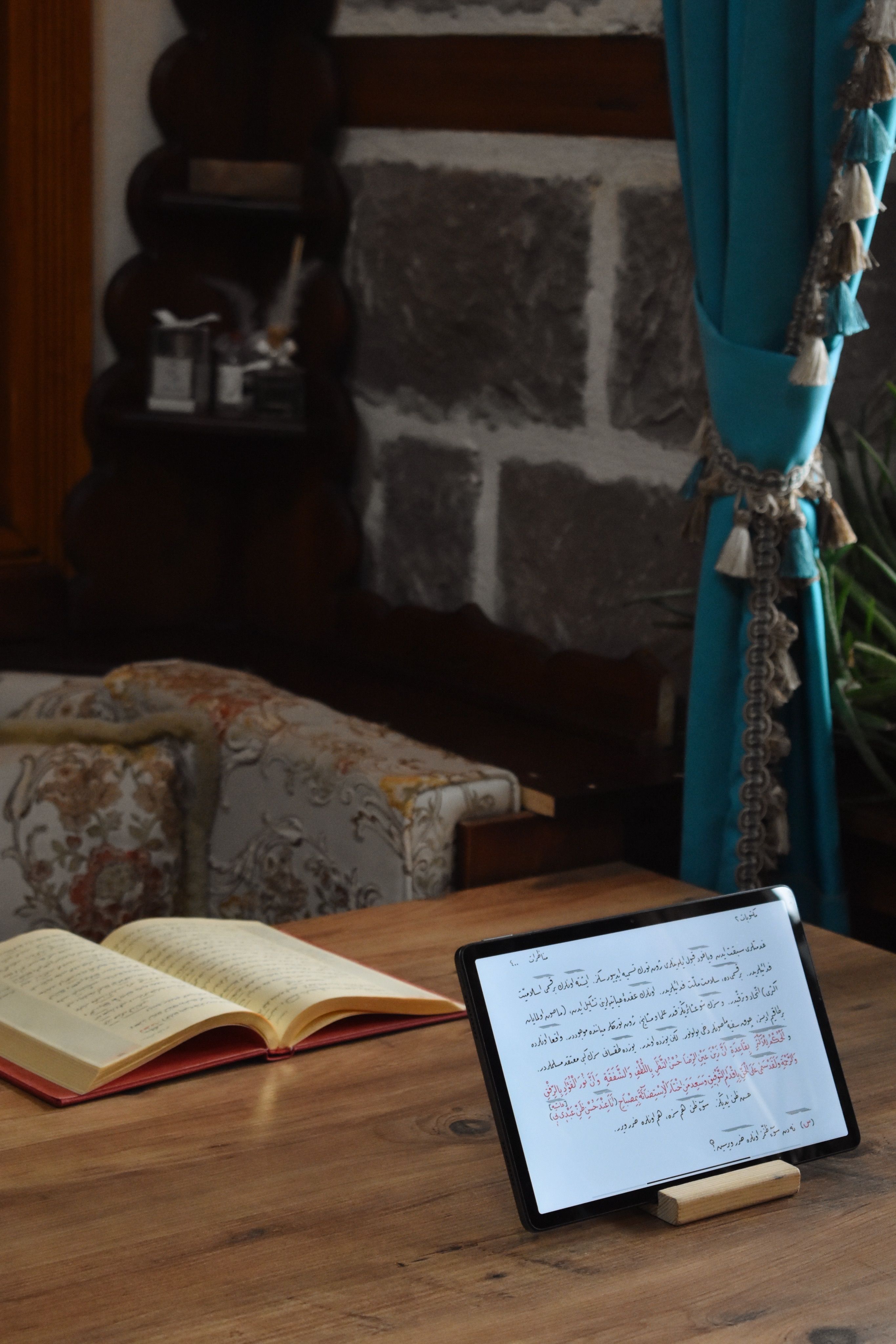 Cozy Reading Nook with Open Book and Tablet Display · Free Stock Photo