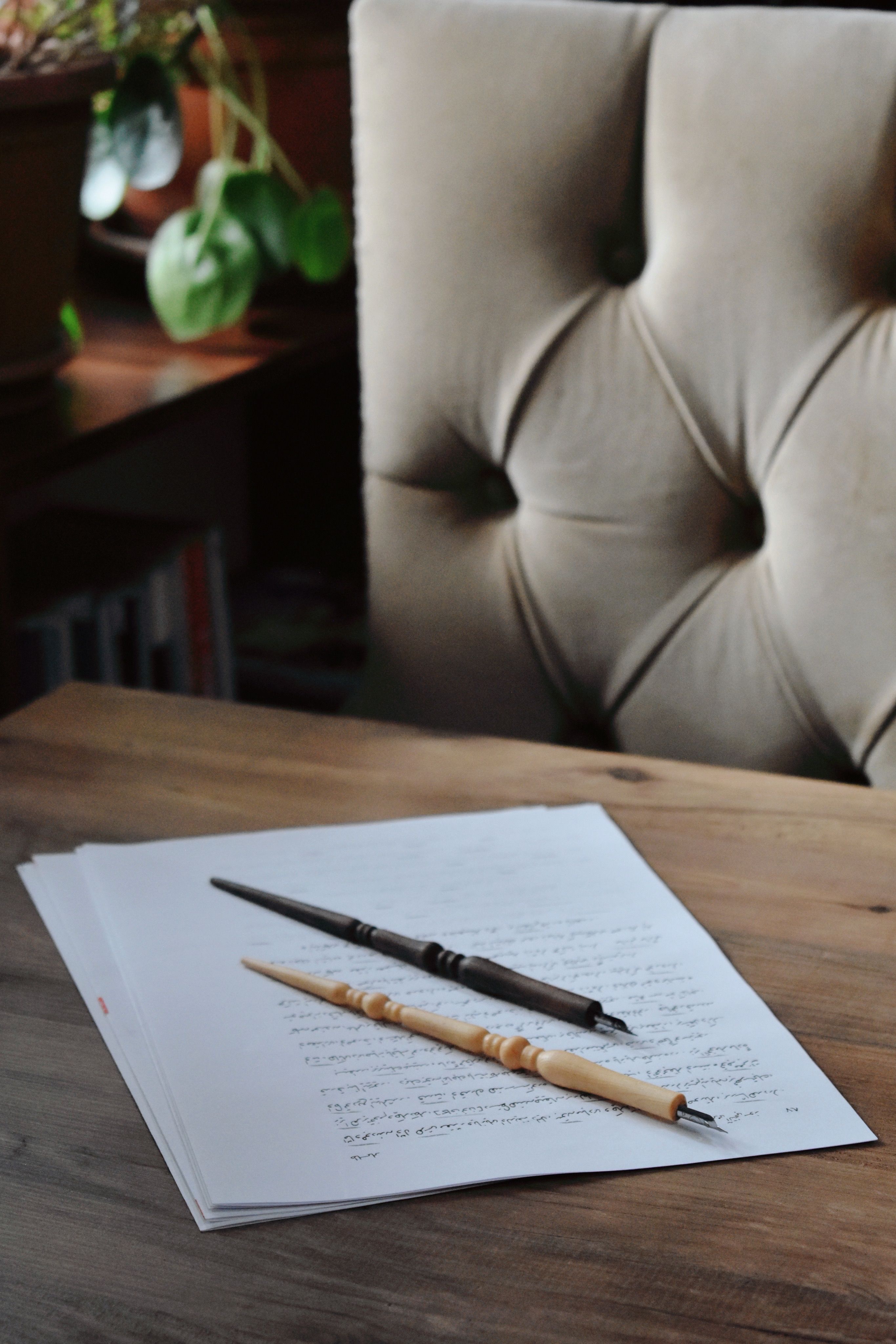 Elegant Quill Pens on Writing Paper by Tufted Chair · Free Stock Photo