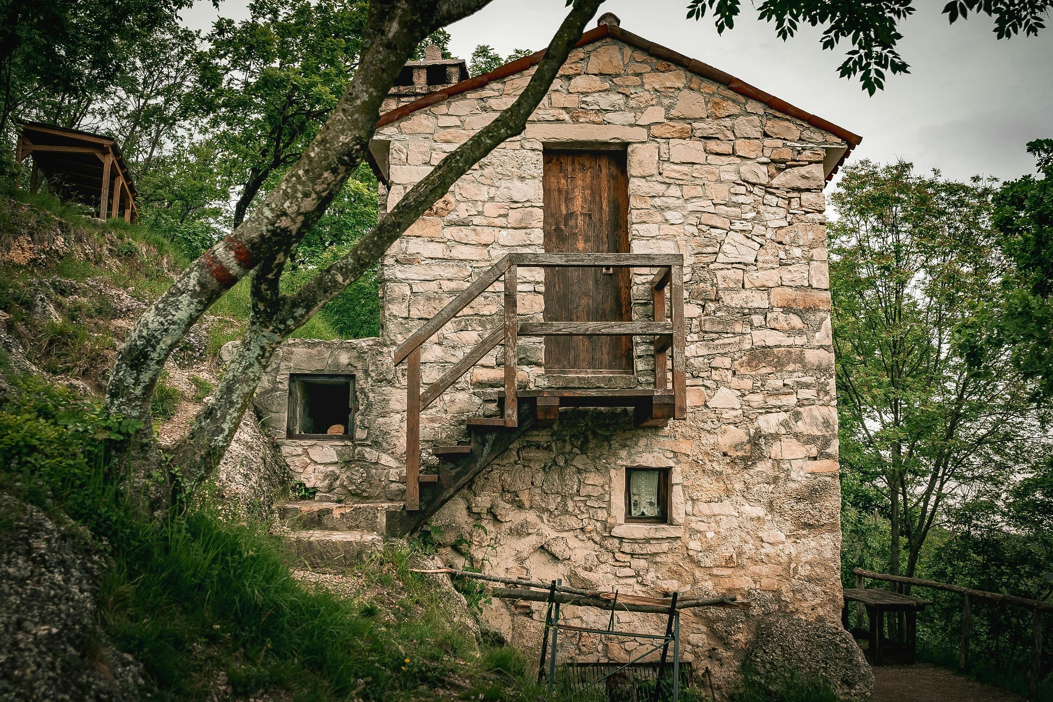 Rustic Stone Cottage in Tranquil Forest Setting · Free Stock Photo