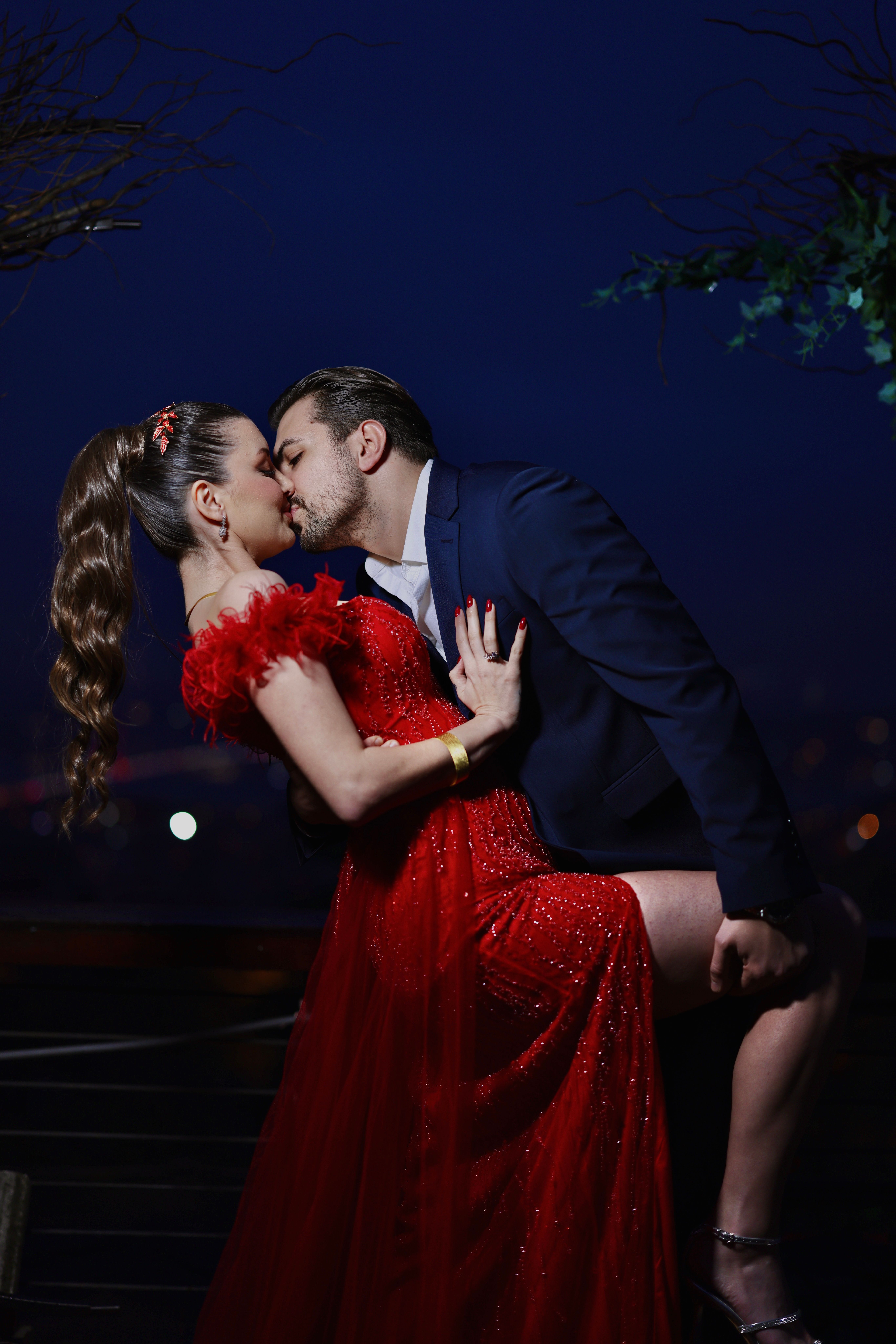 Romantic Nighttime Kiss on Rooftop Terrace · Free Stock Photo