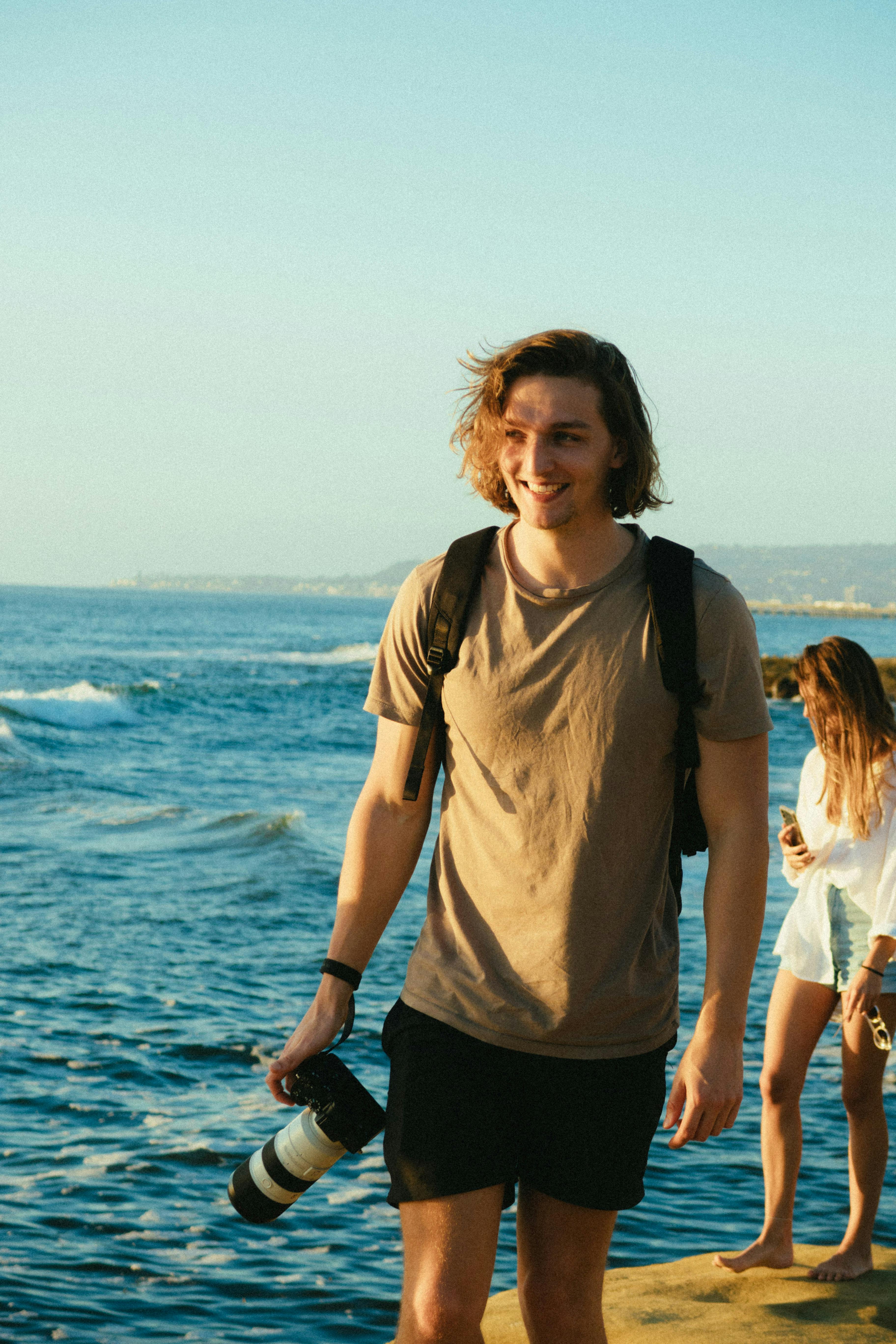 Photo Of Man Carrying Camera · Free Stock Photo