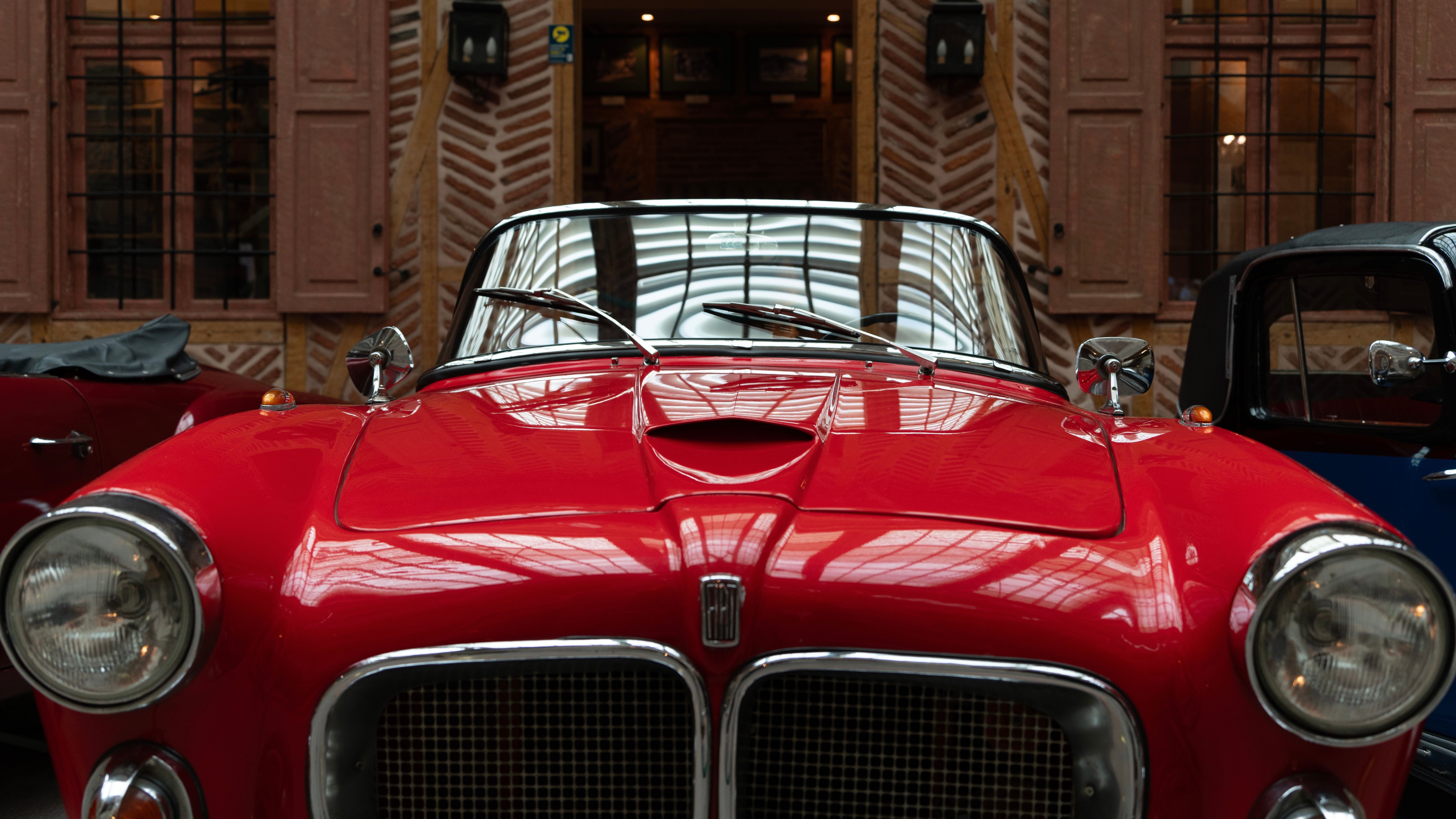 Classic Red Vintage Car in Indoor Setting · Free Stock Photo